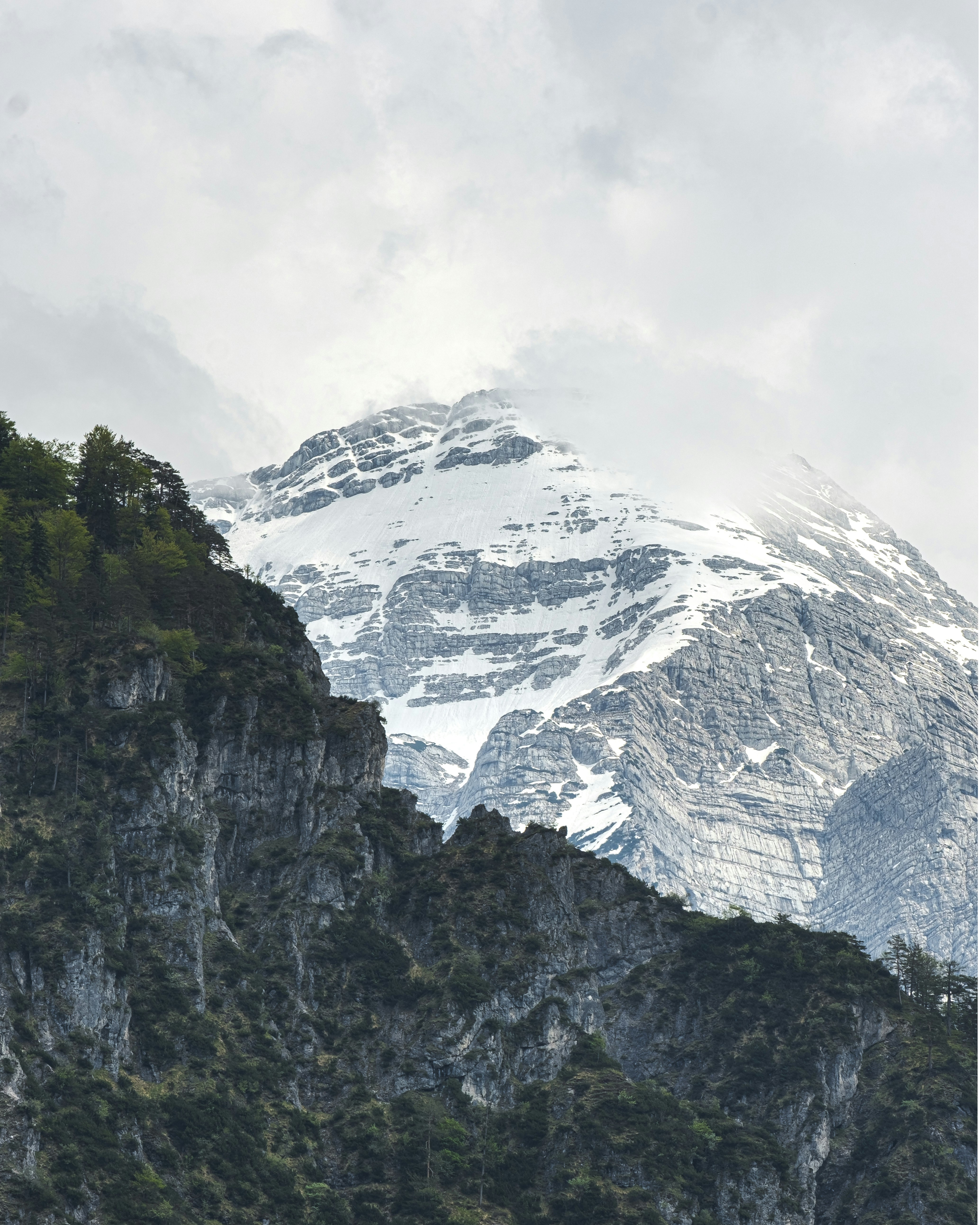snow covered mountain under cloudy sky during daytime