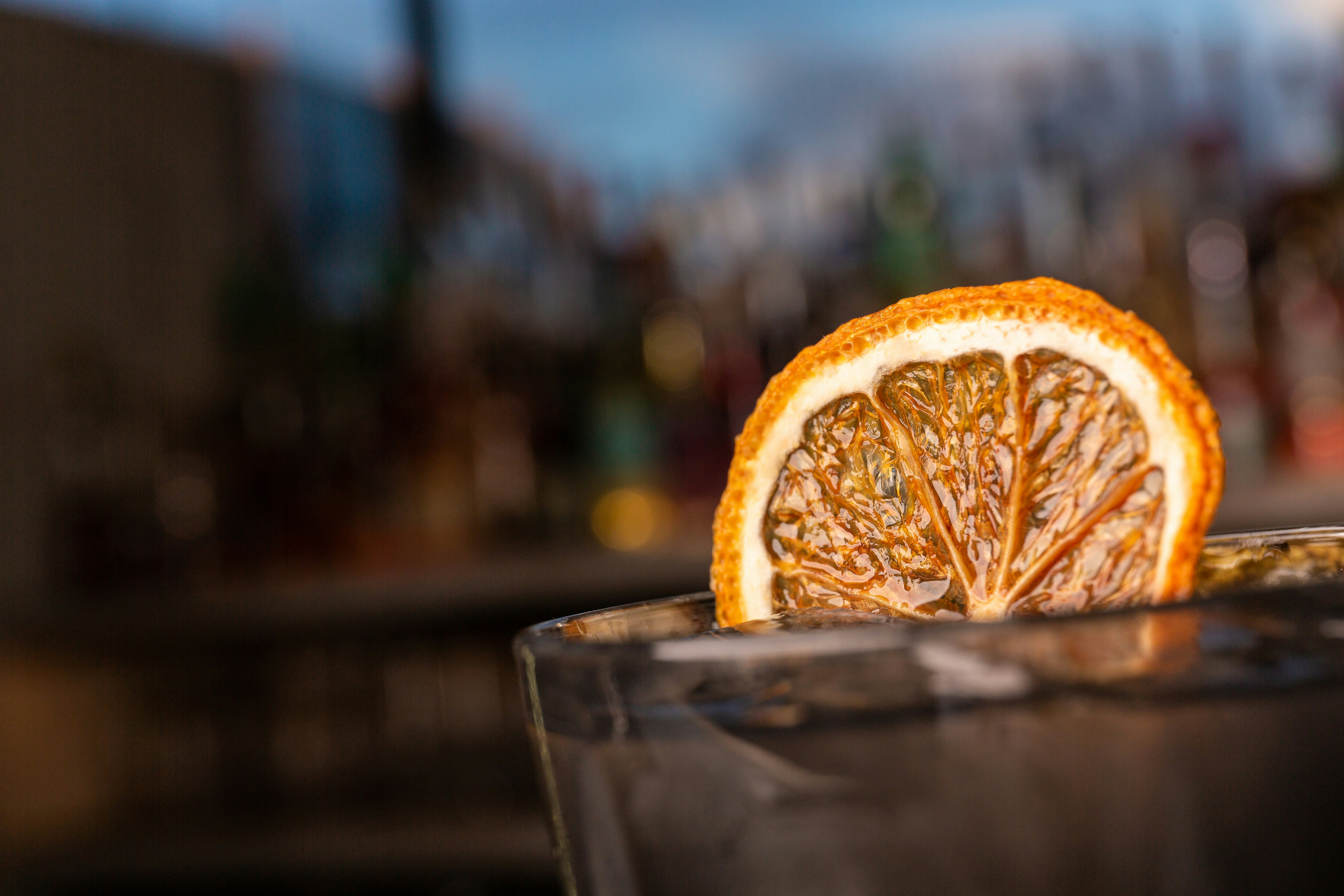 Orange Crown on a Glass Rim in a Warm Bar Blur
