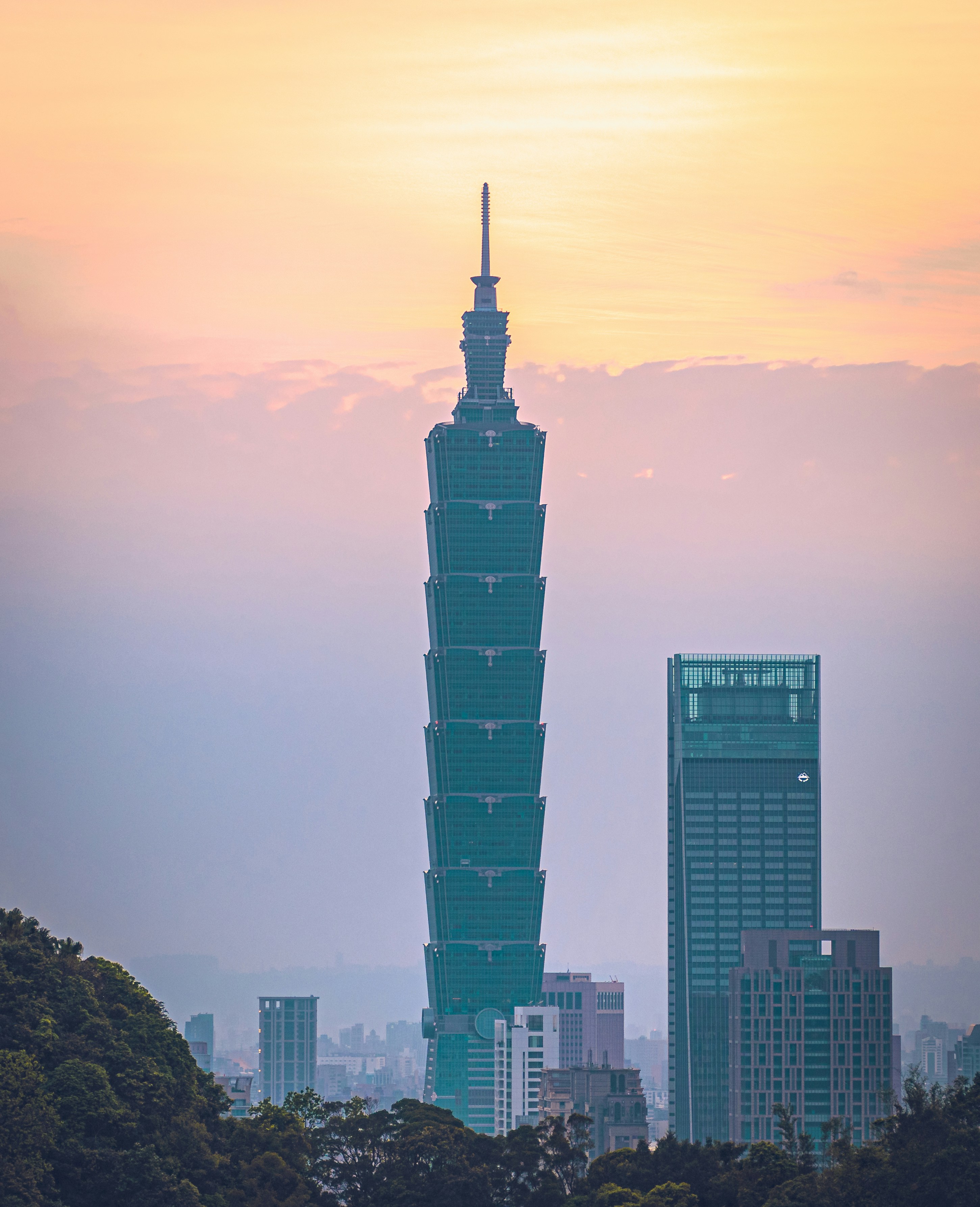Peach Dusk Over Taipei 101: A Skyward Sentinel