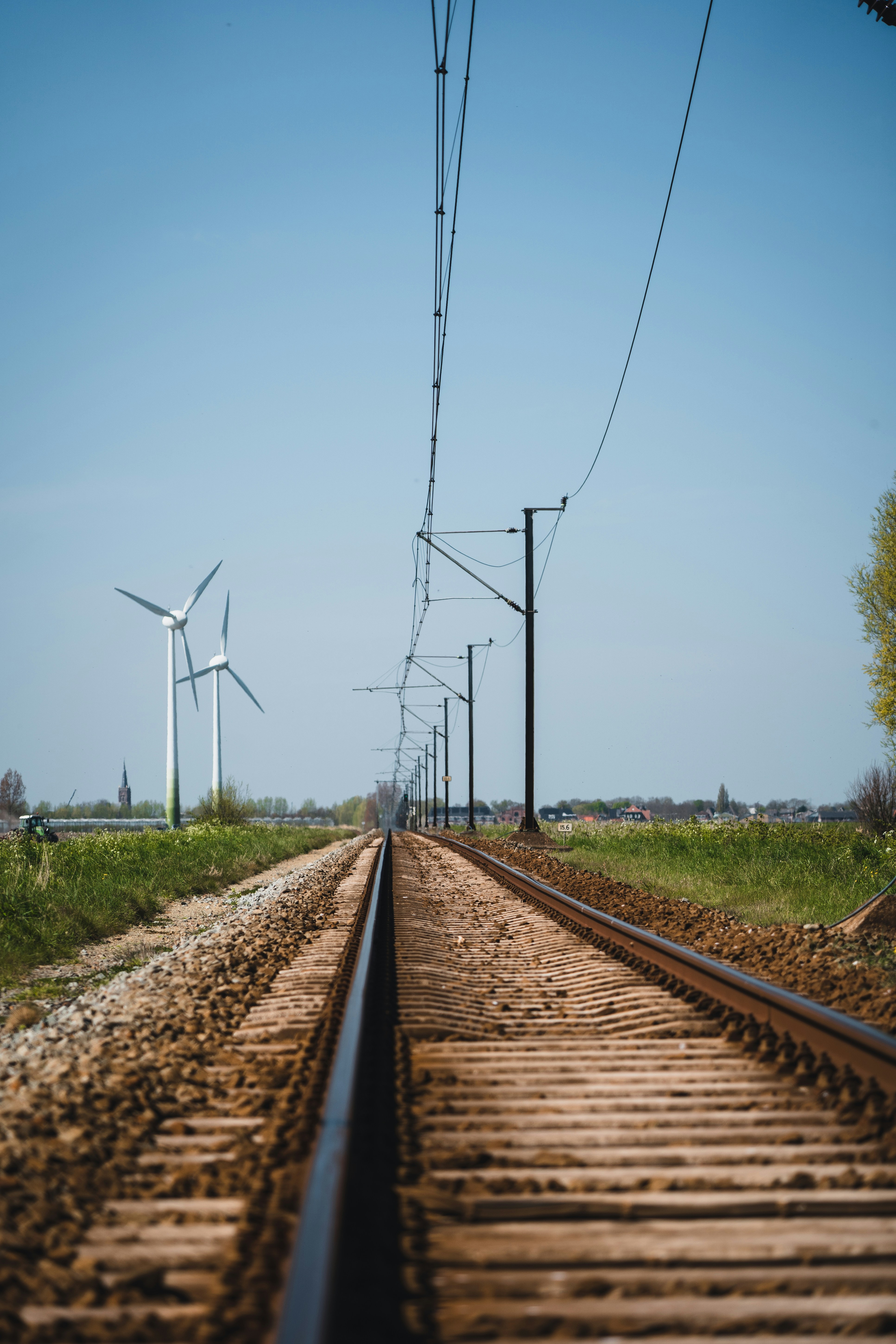 Middle Path: Rails, Lines, and Wind Turbines on a Quiet Horizon