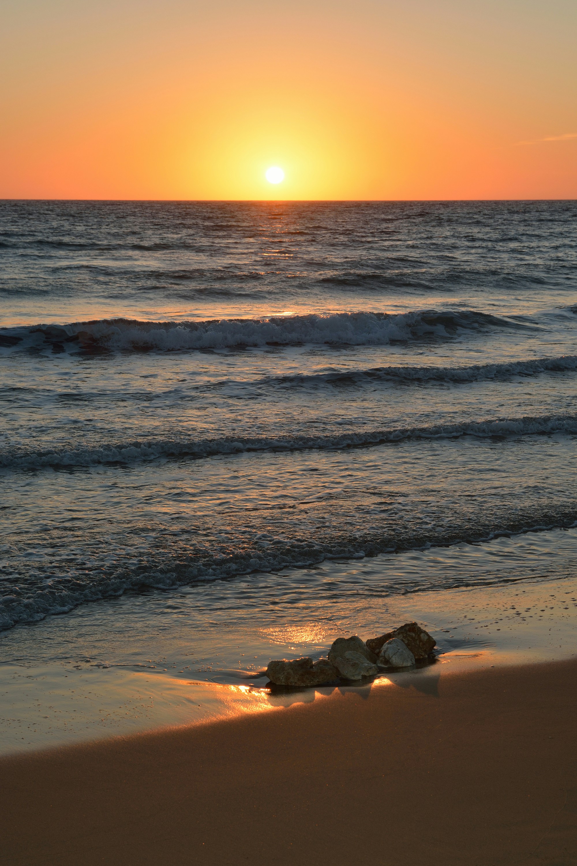 Horizon Kissed by Sunset: Pebbles on a Quiet Beach