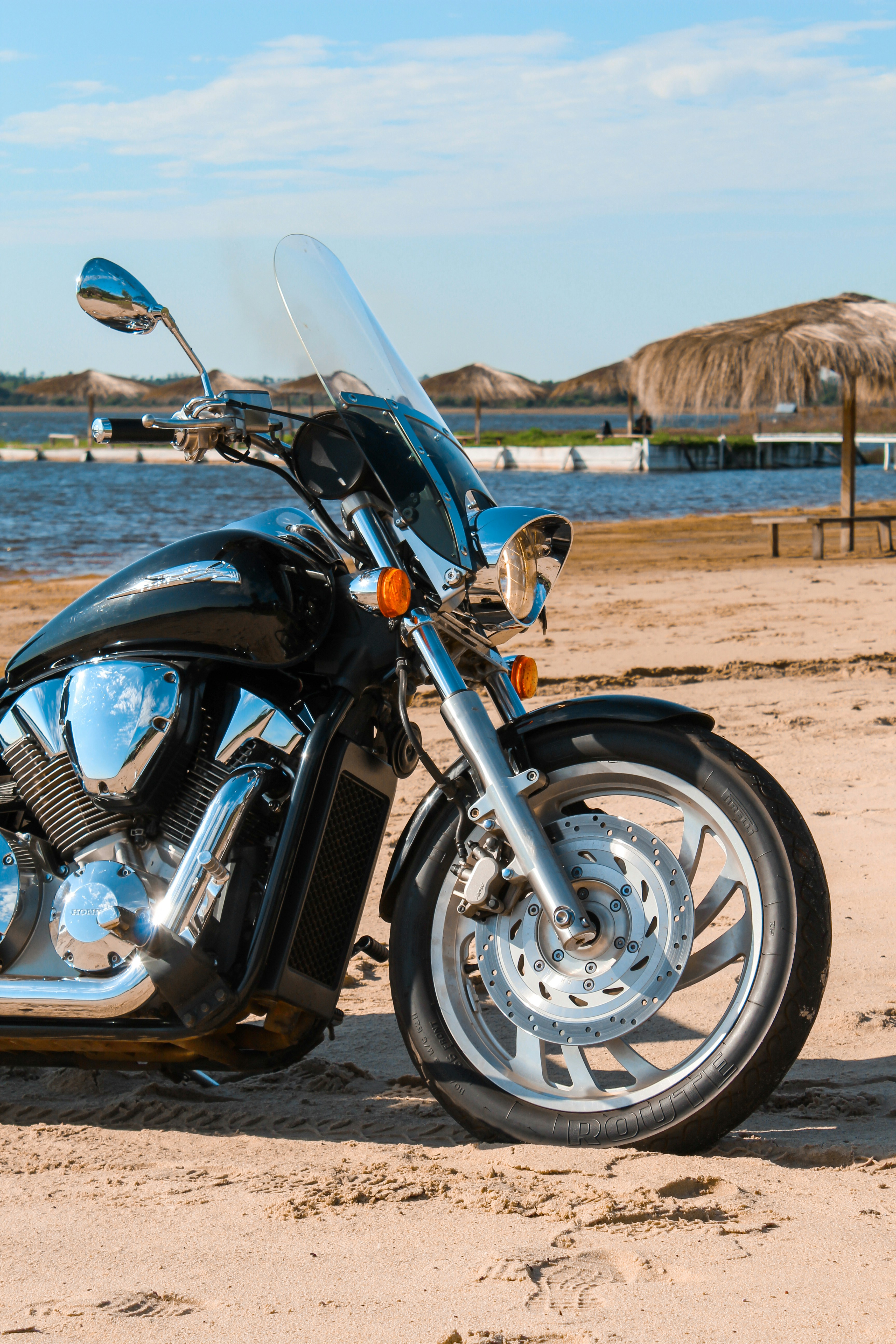 Blue and silver cruiser motorcycle on brown sand during daytime photo ...