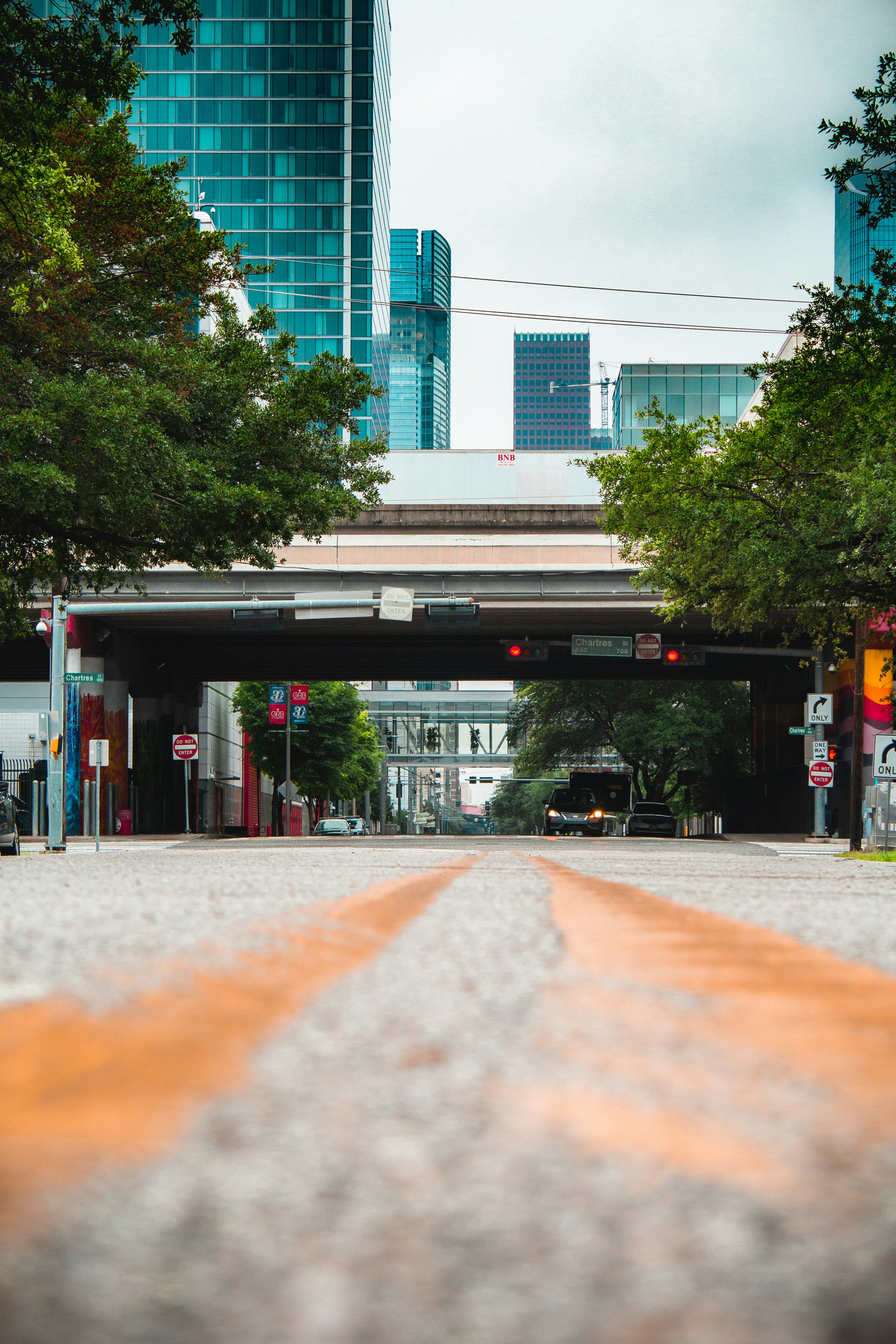 Orange Veins of a City Street Recede Toward an Underpass