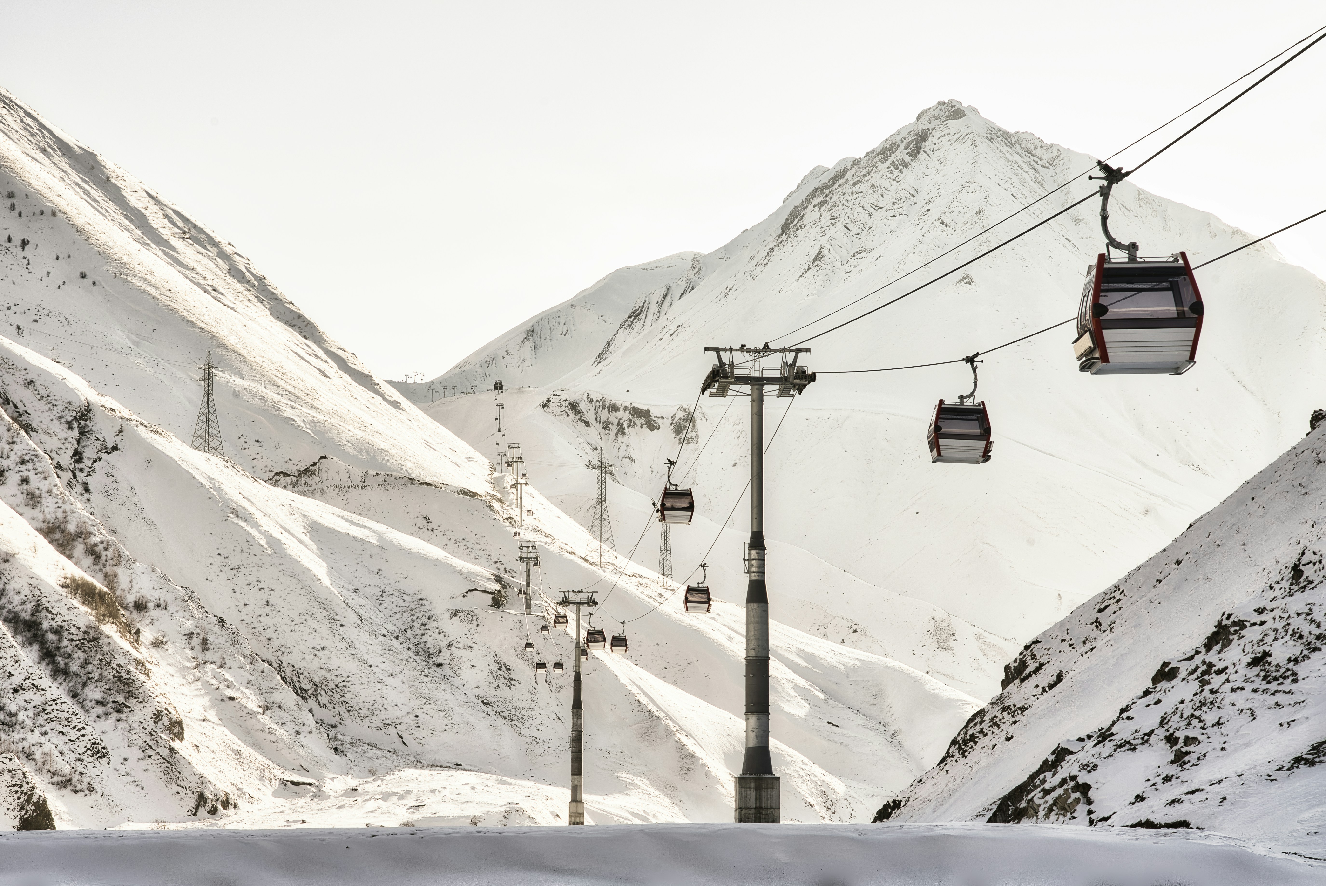 Cable cars over snow covered mountain photo – Free Grey Image on Unsplash