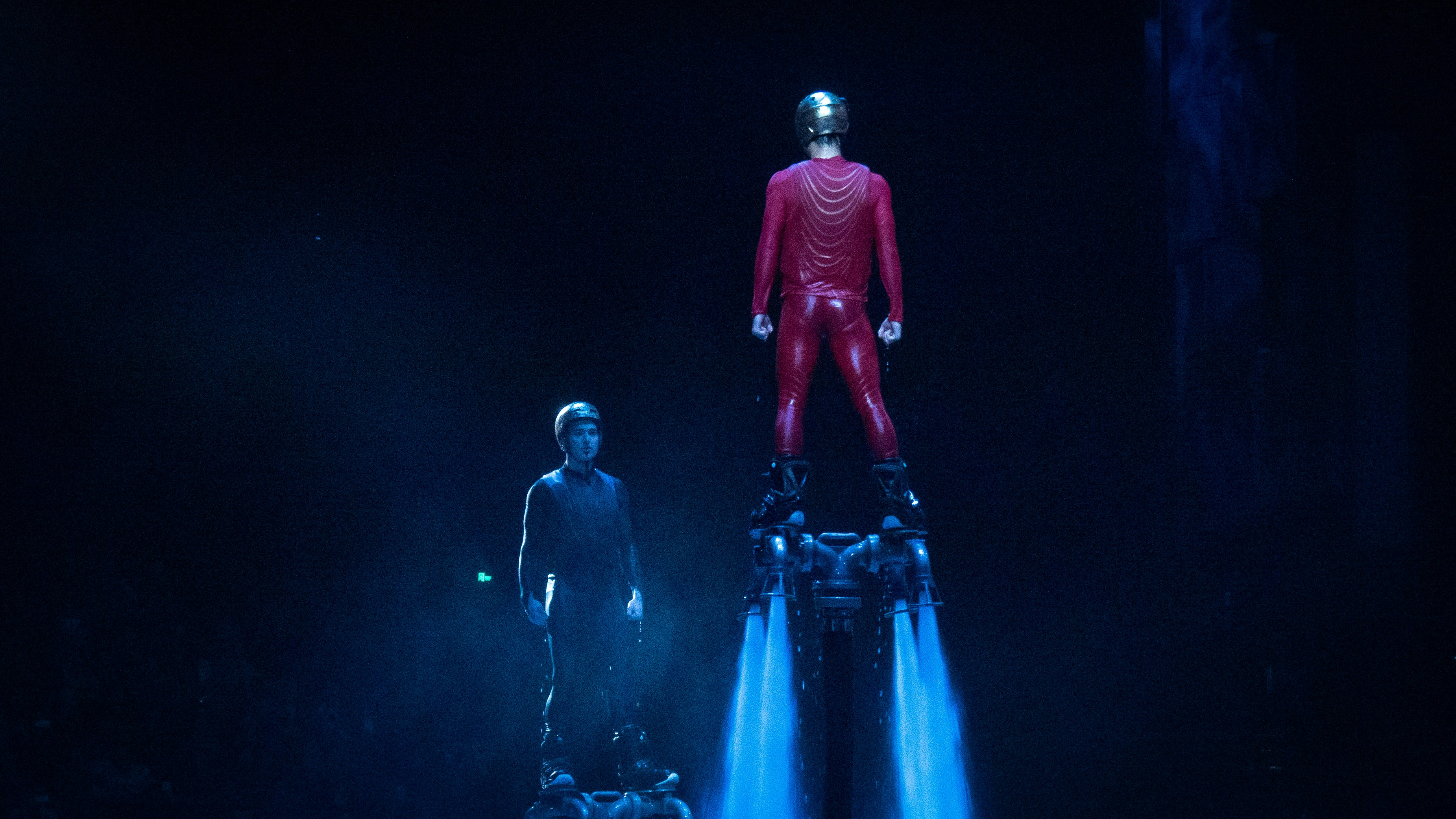 Standby on the Platform: Twin Figures Beneath a Neon Spotlight