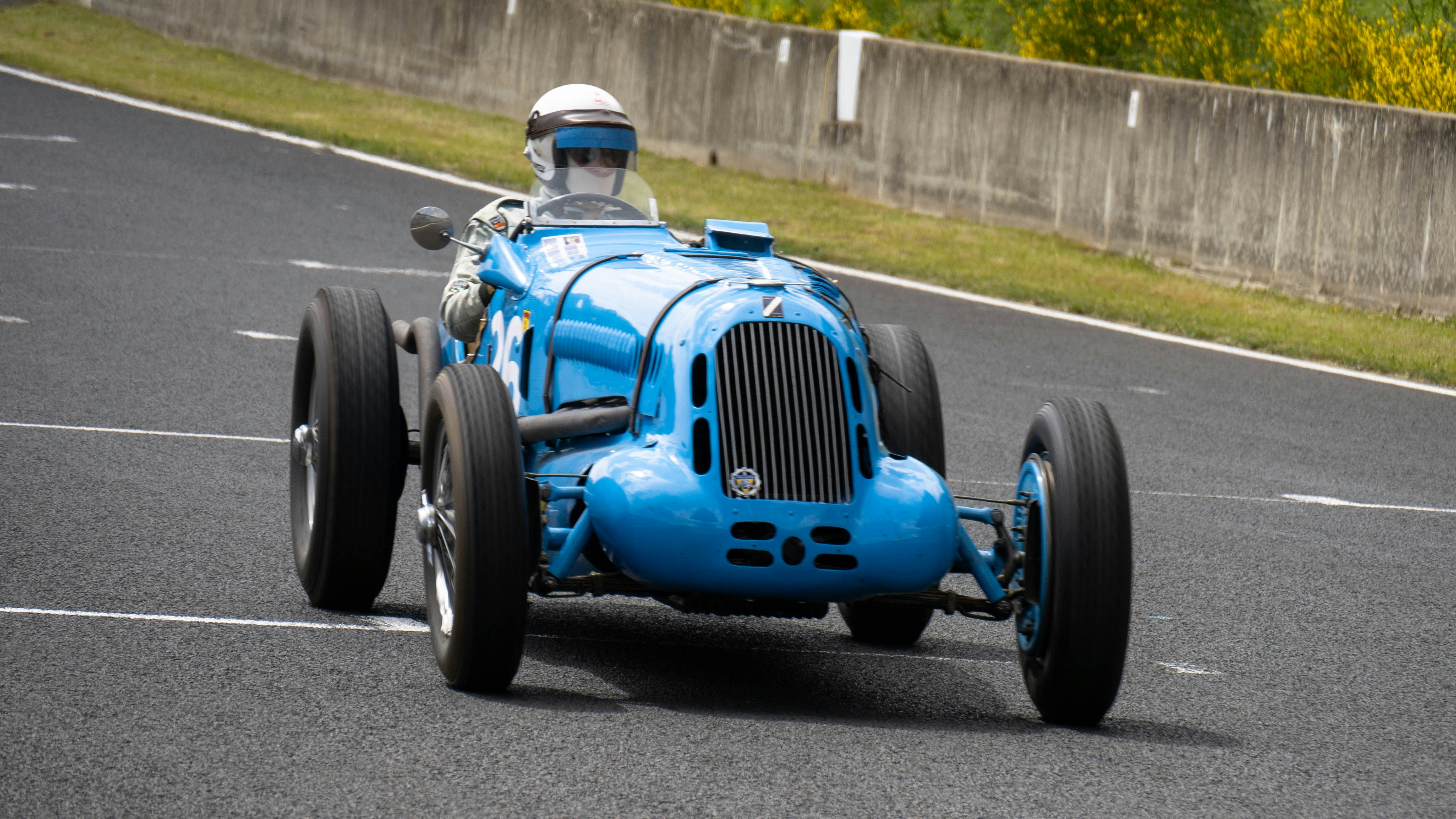 Blue Classic Roadster Cutting the Turn on a Quiet Track