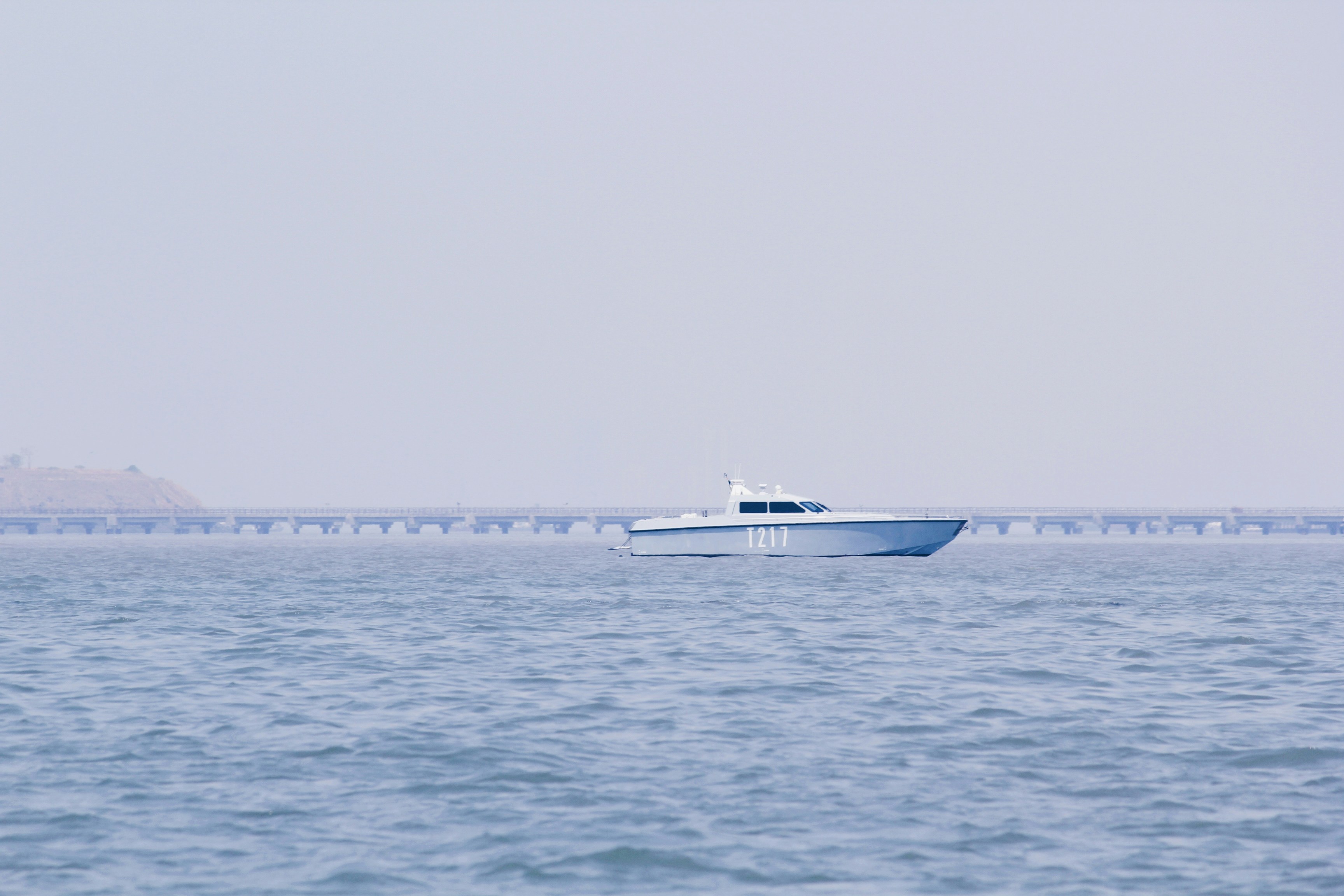 white boat on sea during daytime