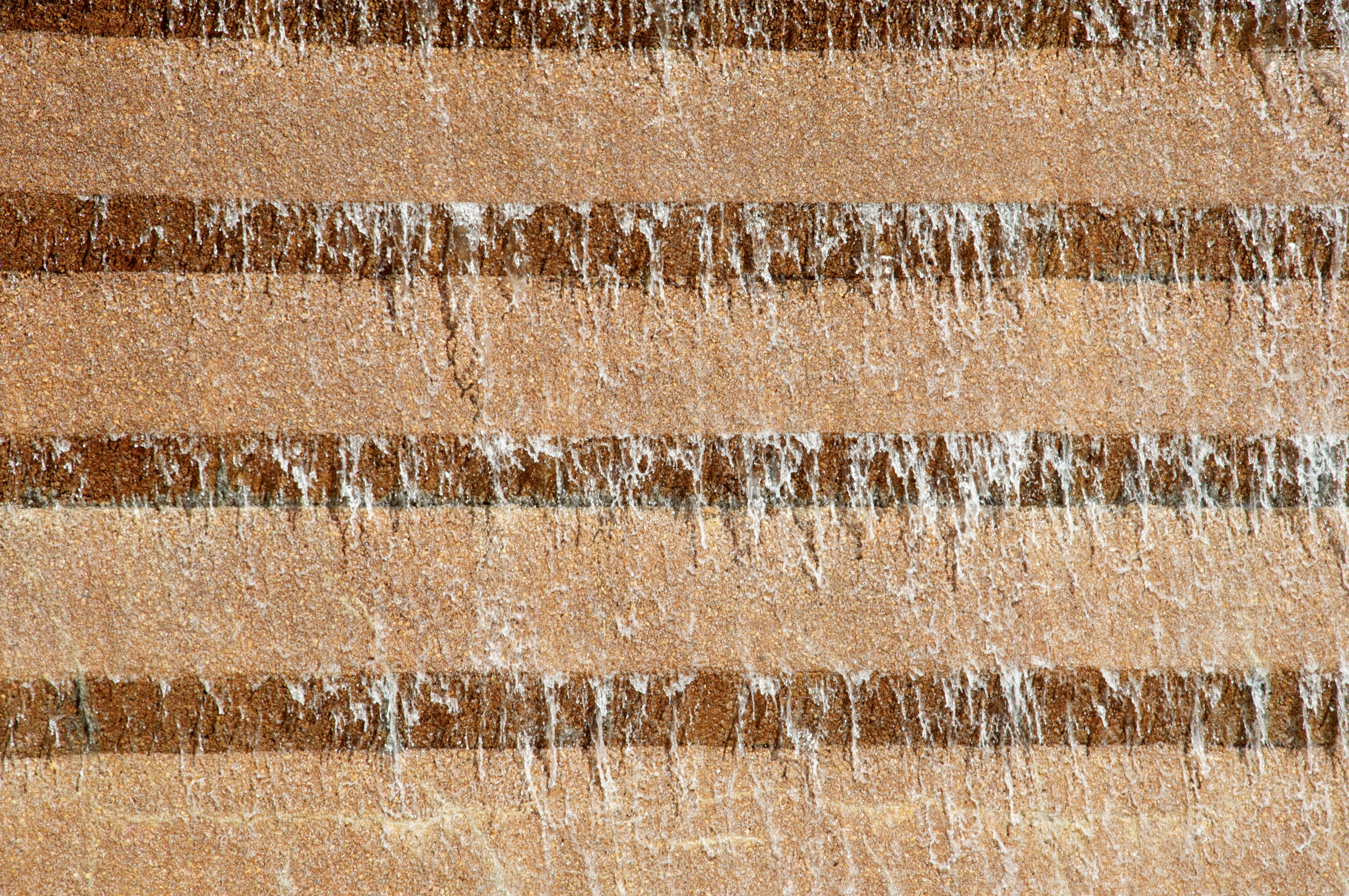 Abstract painting with horizontal brown and beige stripes and a textured surface.