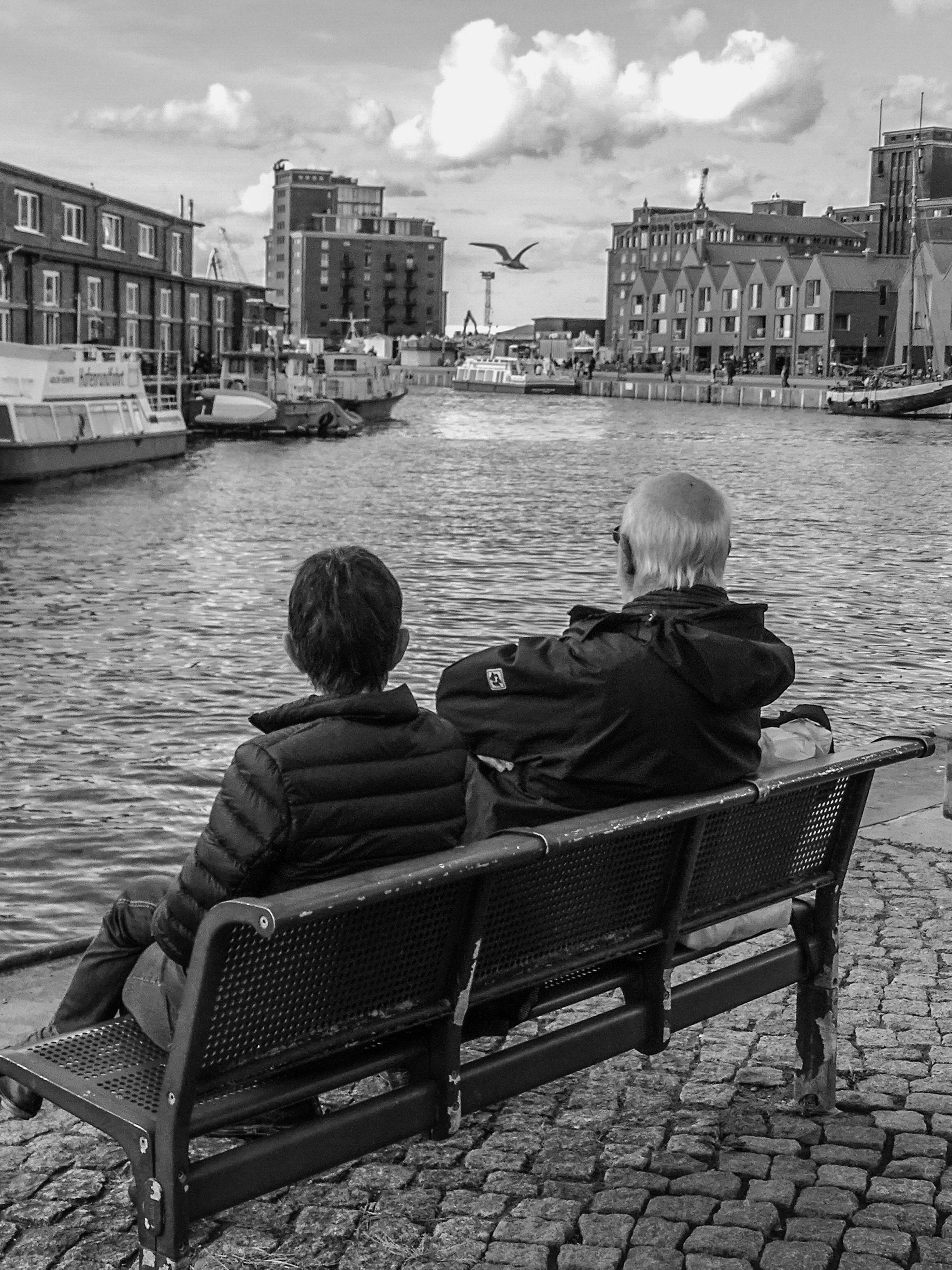 Monochrome Harbor: A Quiet Moment on the Canal Bench