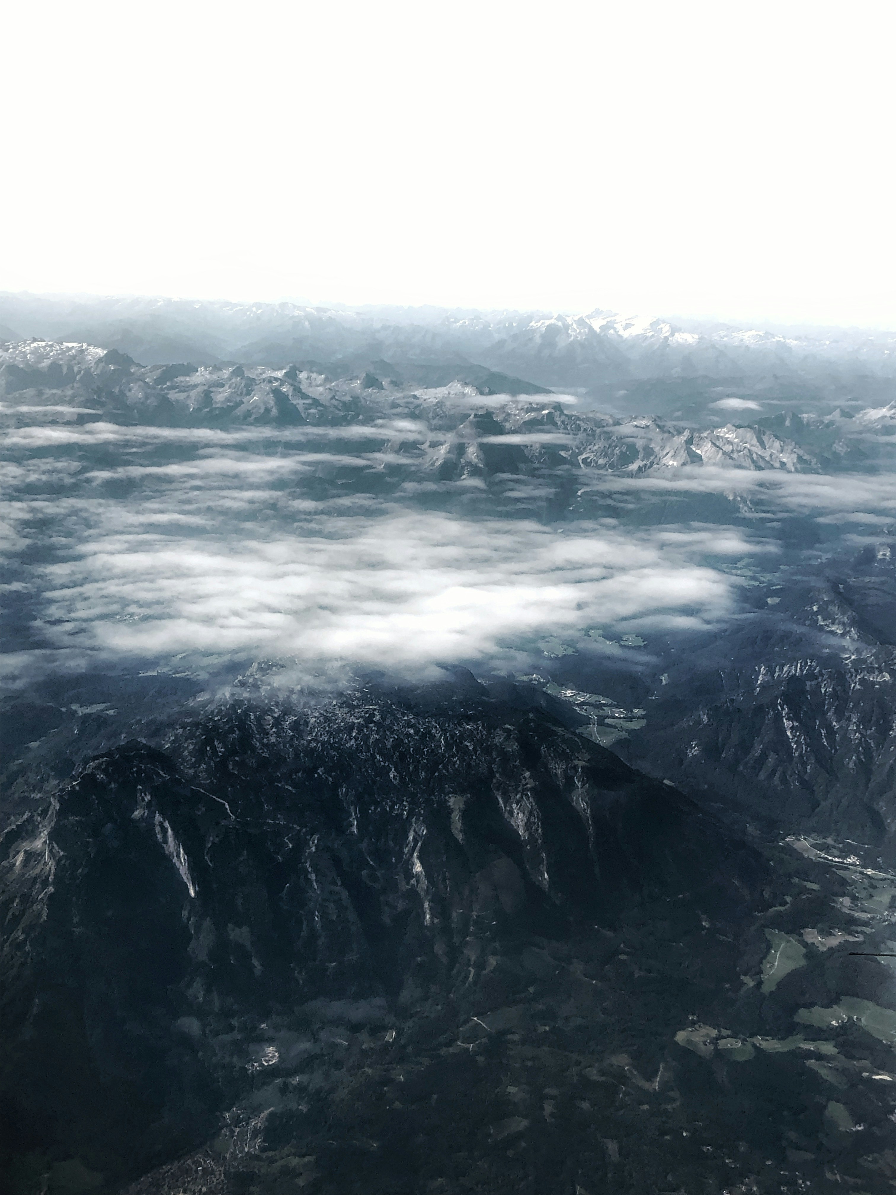 Veil of Clouds Over Majestic Peaks