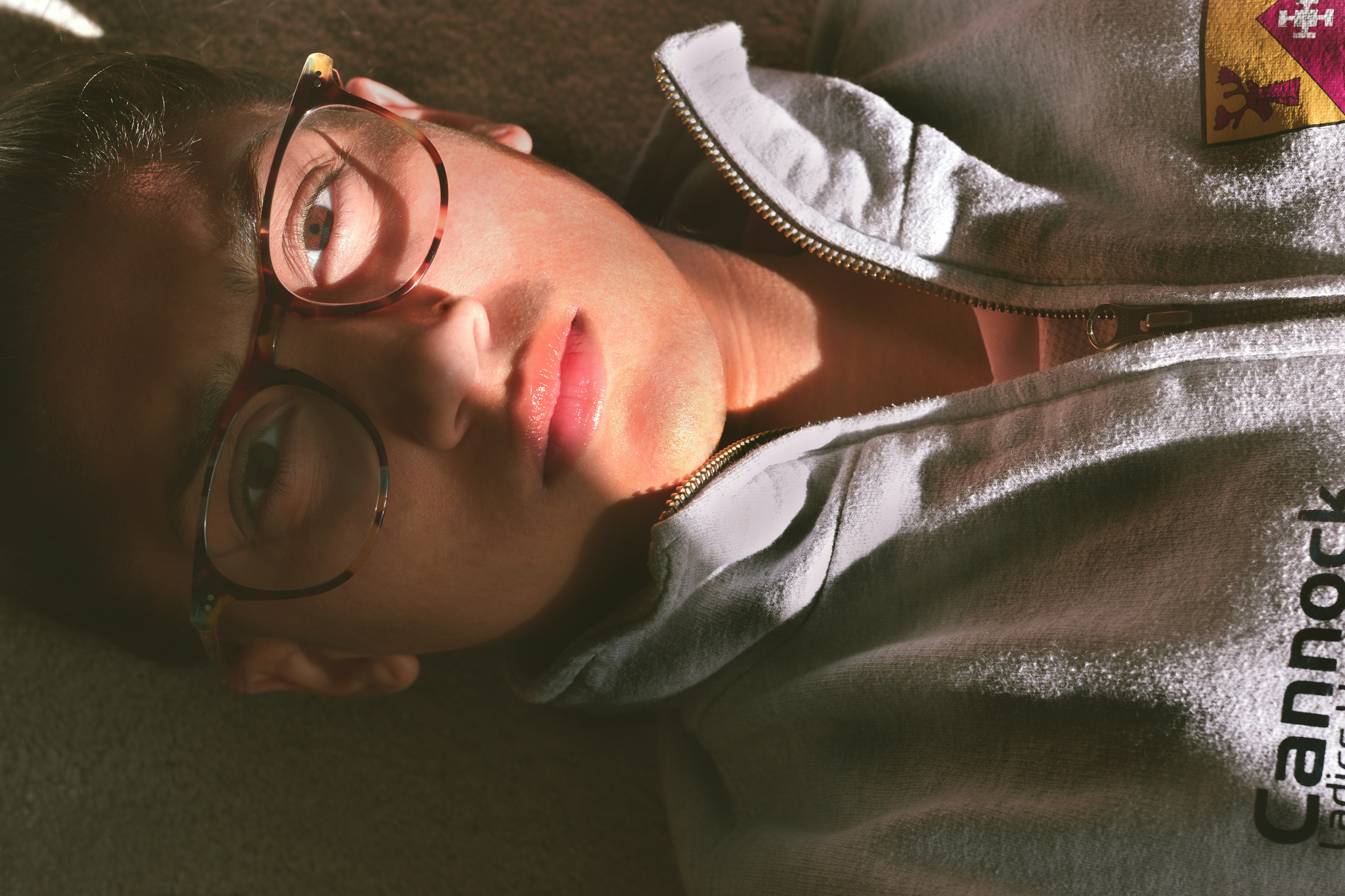 Soft Glow Portrait: Hoodie-Clad Gaze Under Gentle Indoor Light