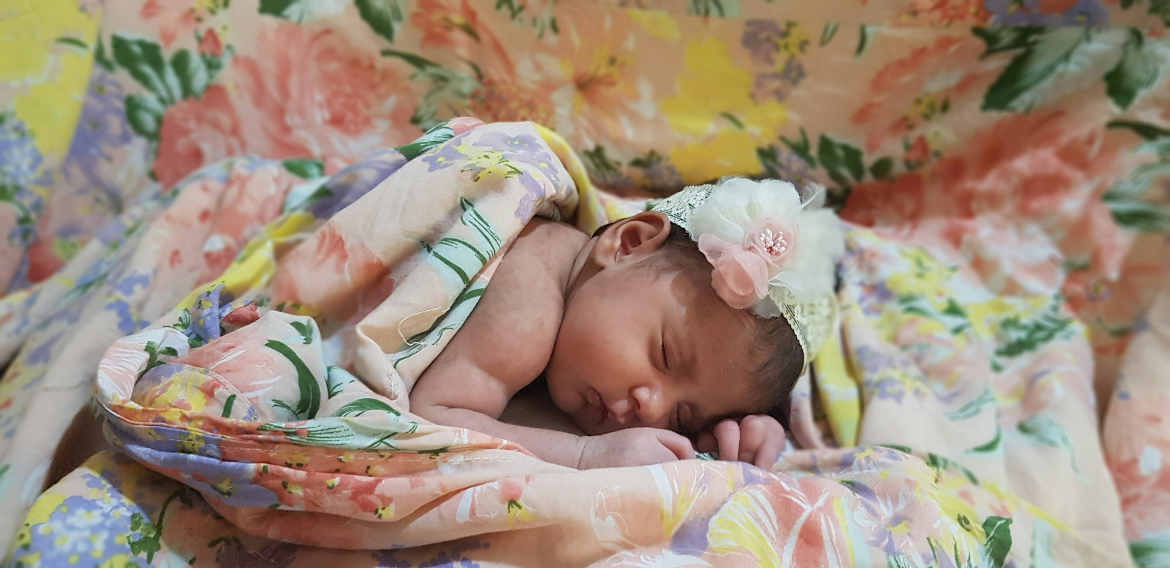 Soft Slumber: a newborn nestled in pastel floral embrace