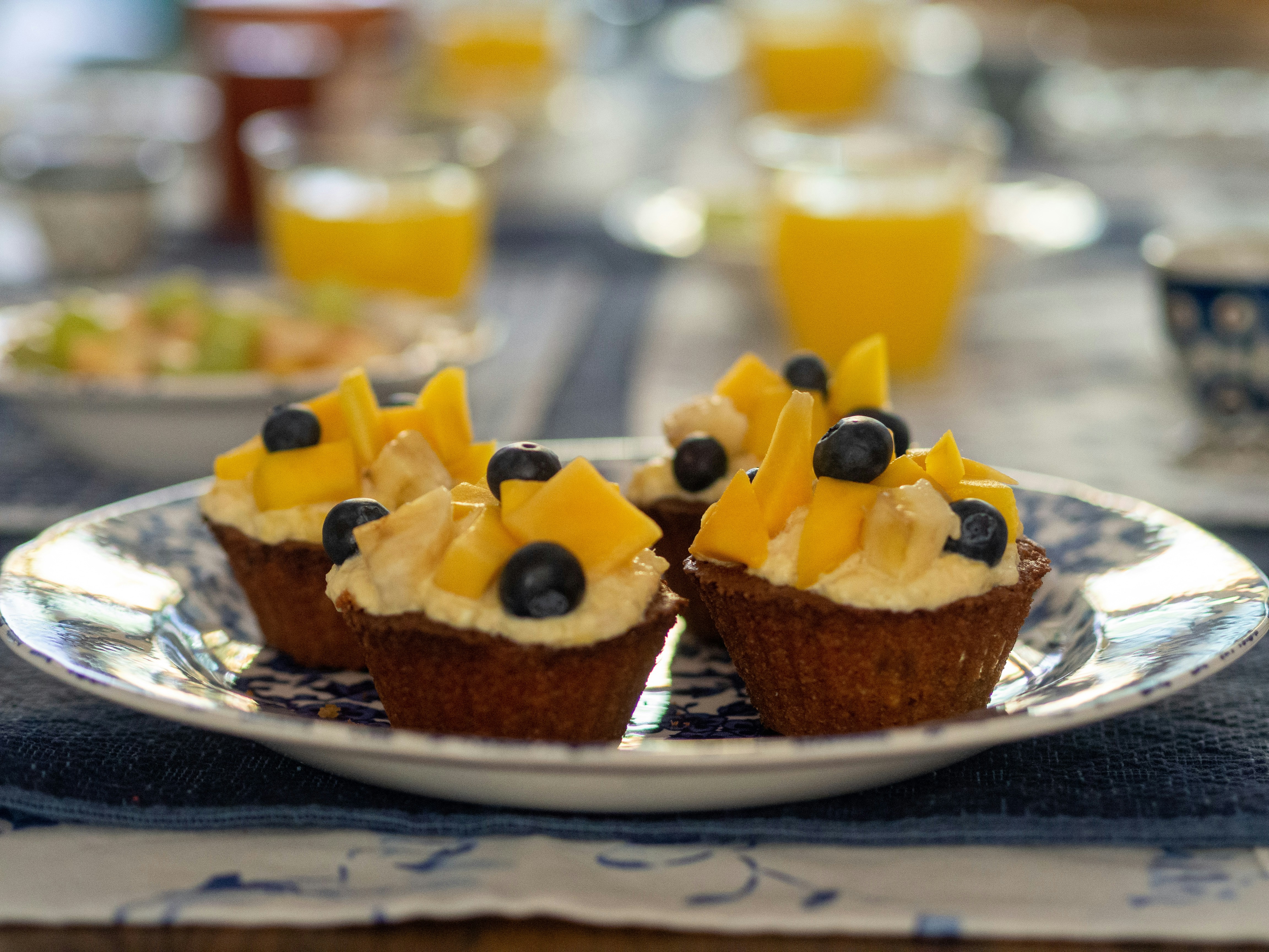 Mango-Topped Cupcakes on a Blue-Patterned Plate