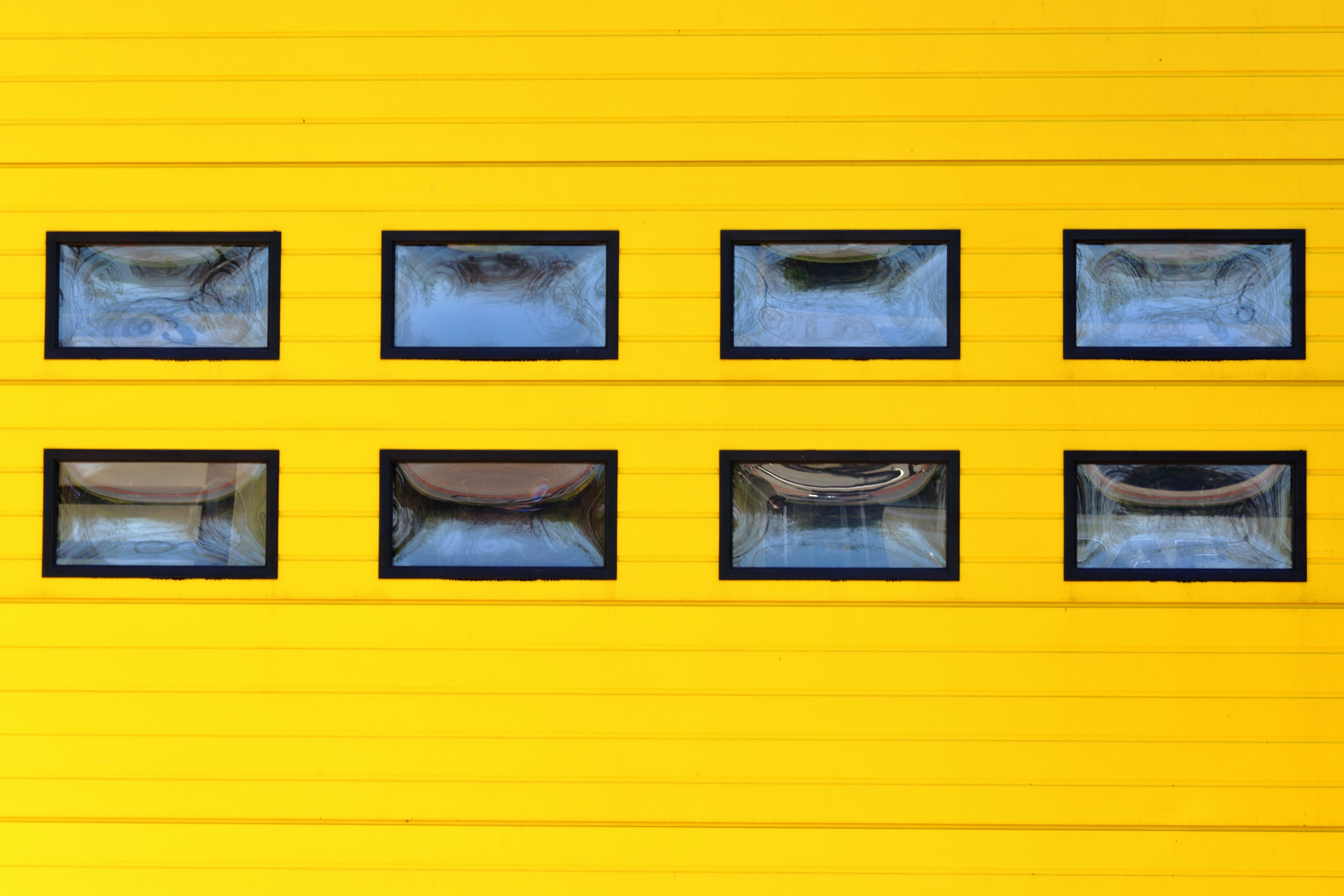 A yellow garage door with six windows and a stop sign photo – Free ...