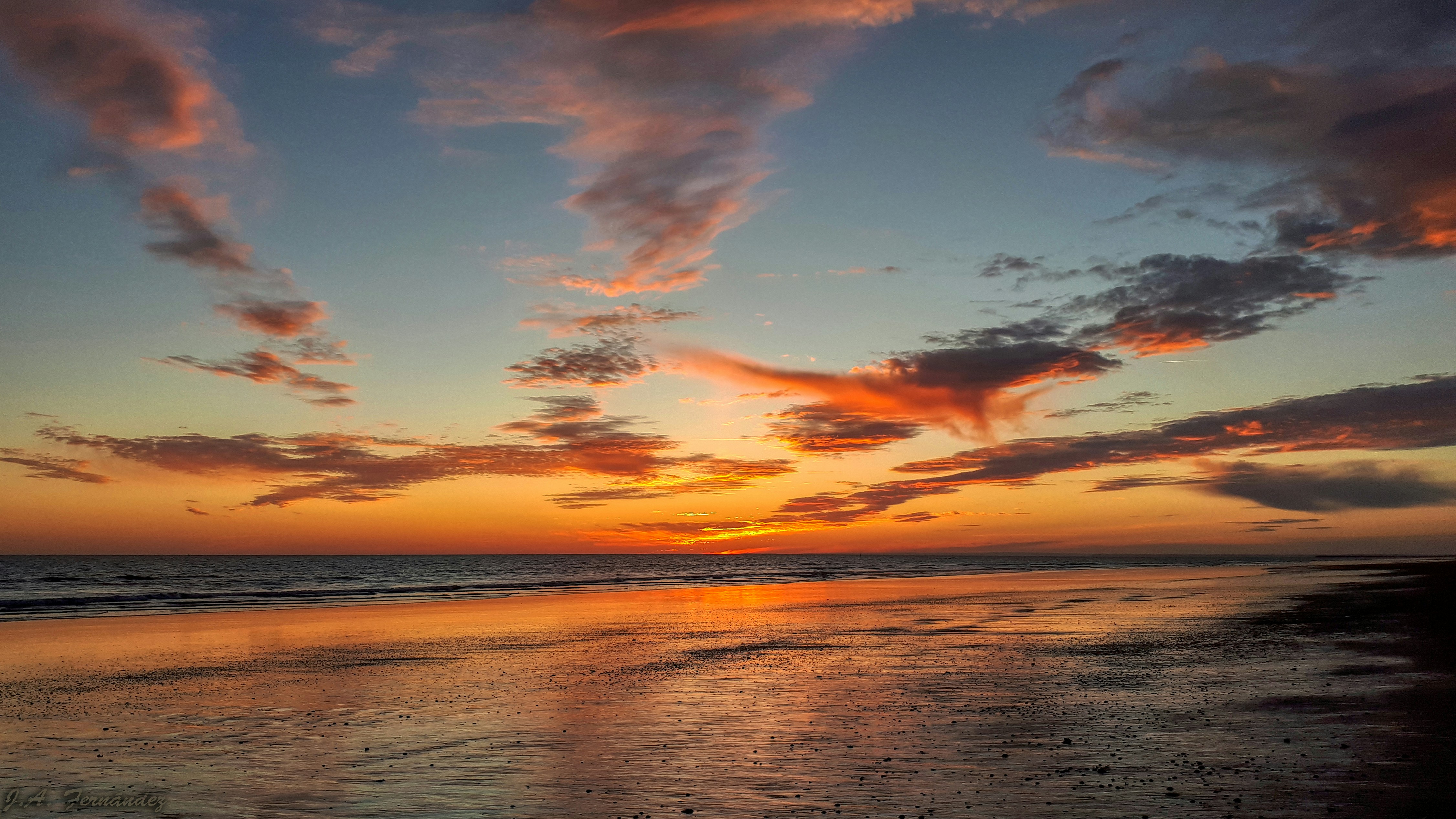 Sunset on the beaches of Huelva | body of water under blue sky during sunset