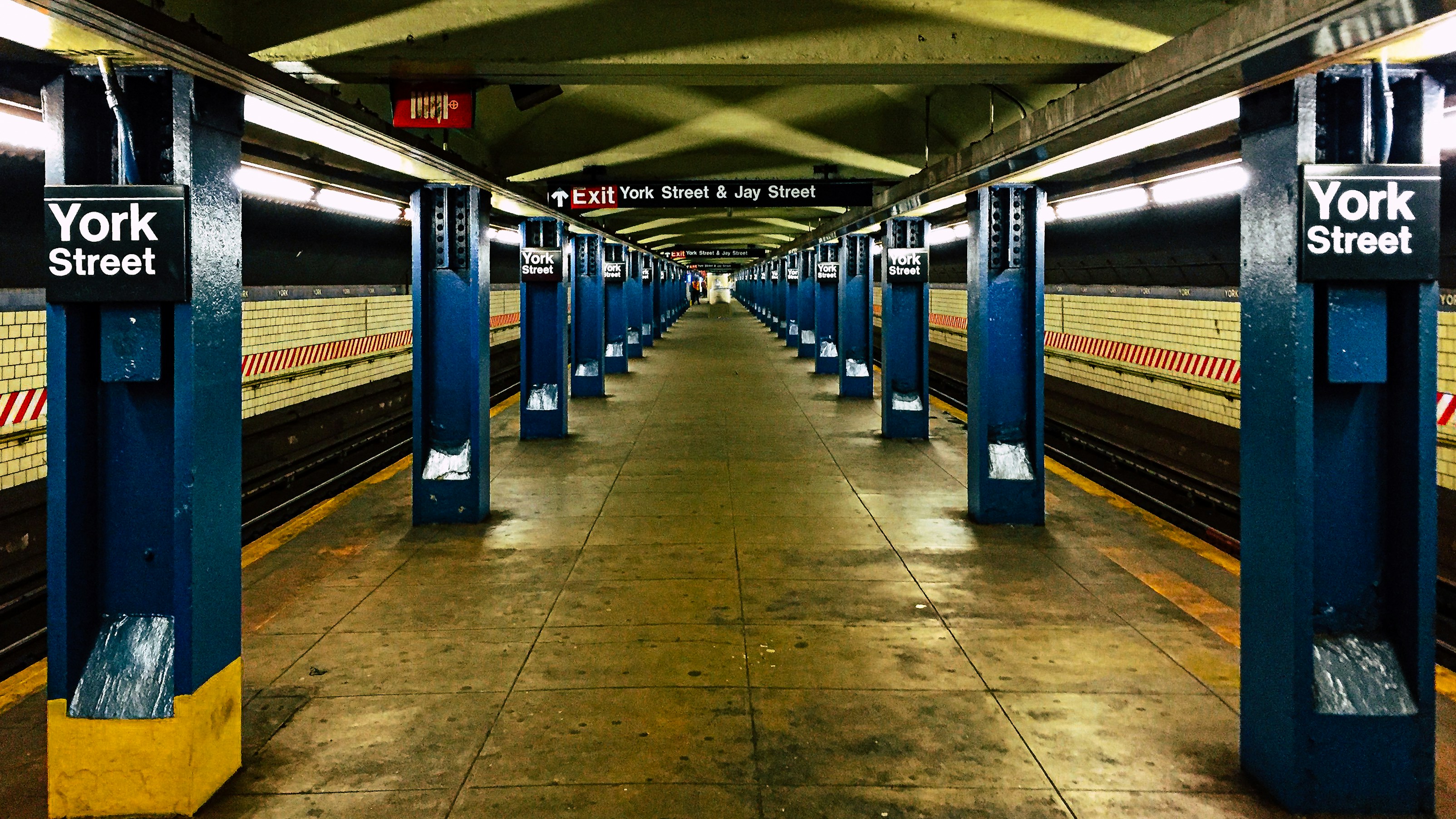 A subway station with blue and yellow stalls photo – Free Brooklyn ...