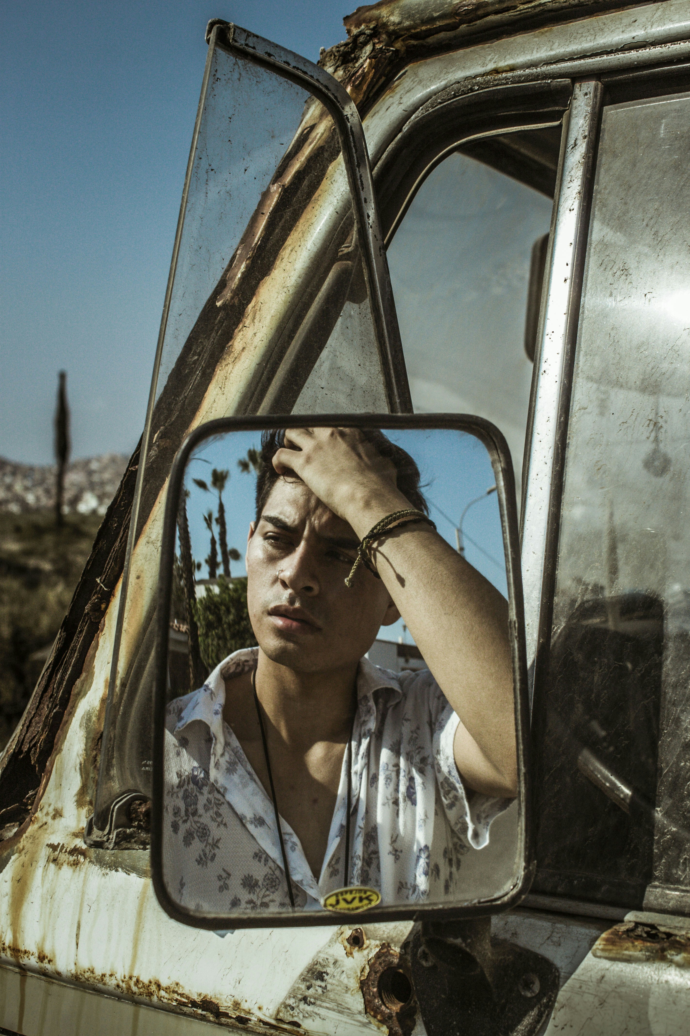 man in white and blue button up shirt sitting on car seat