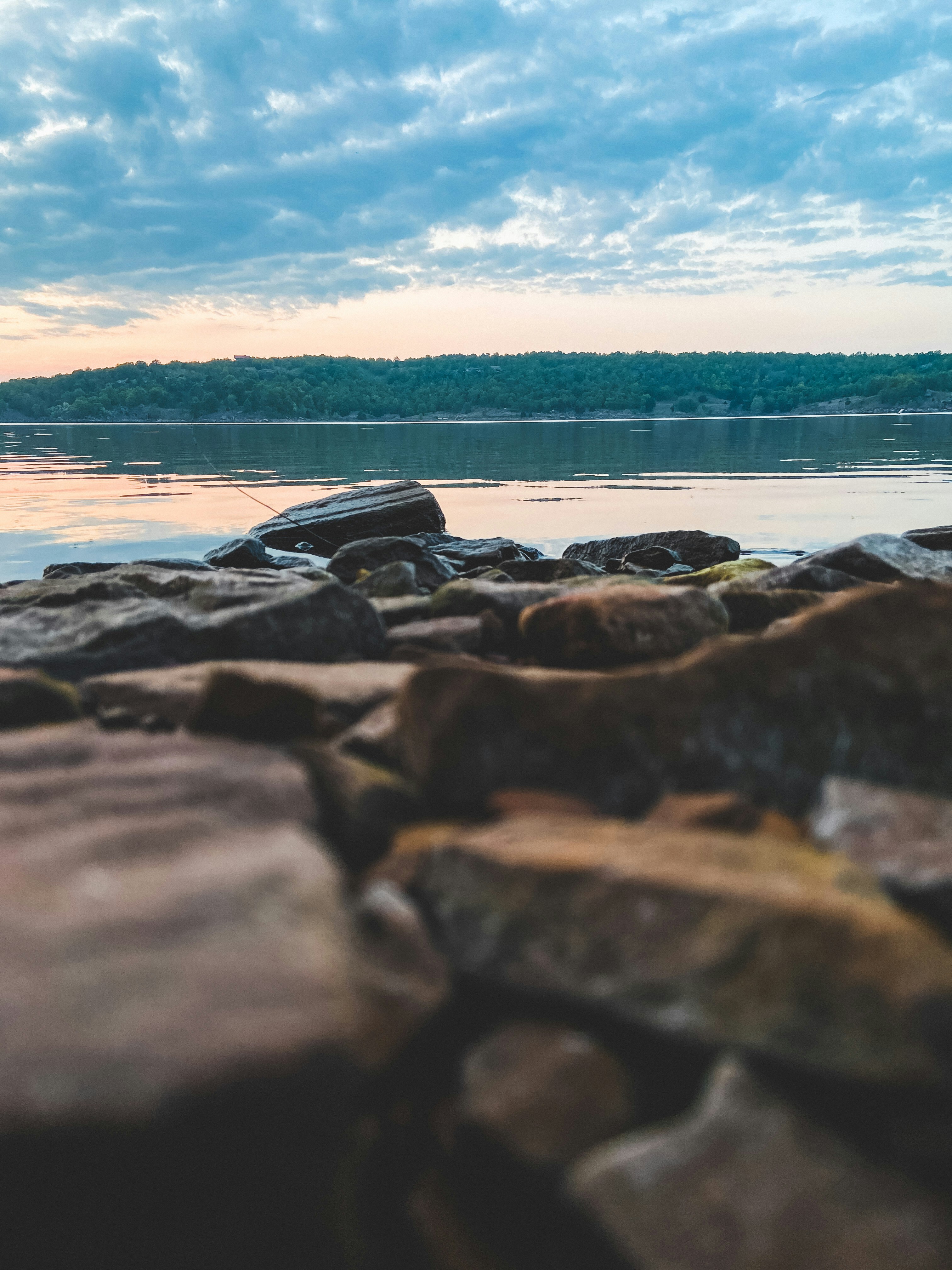 Rugged shoreline at blue hour by a serene lake