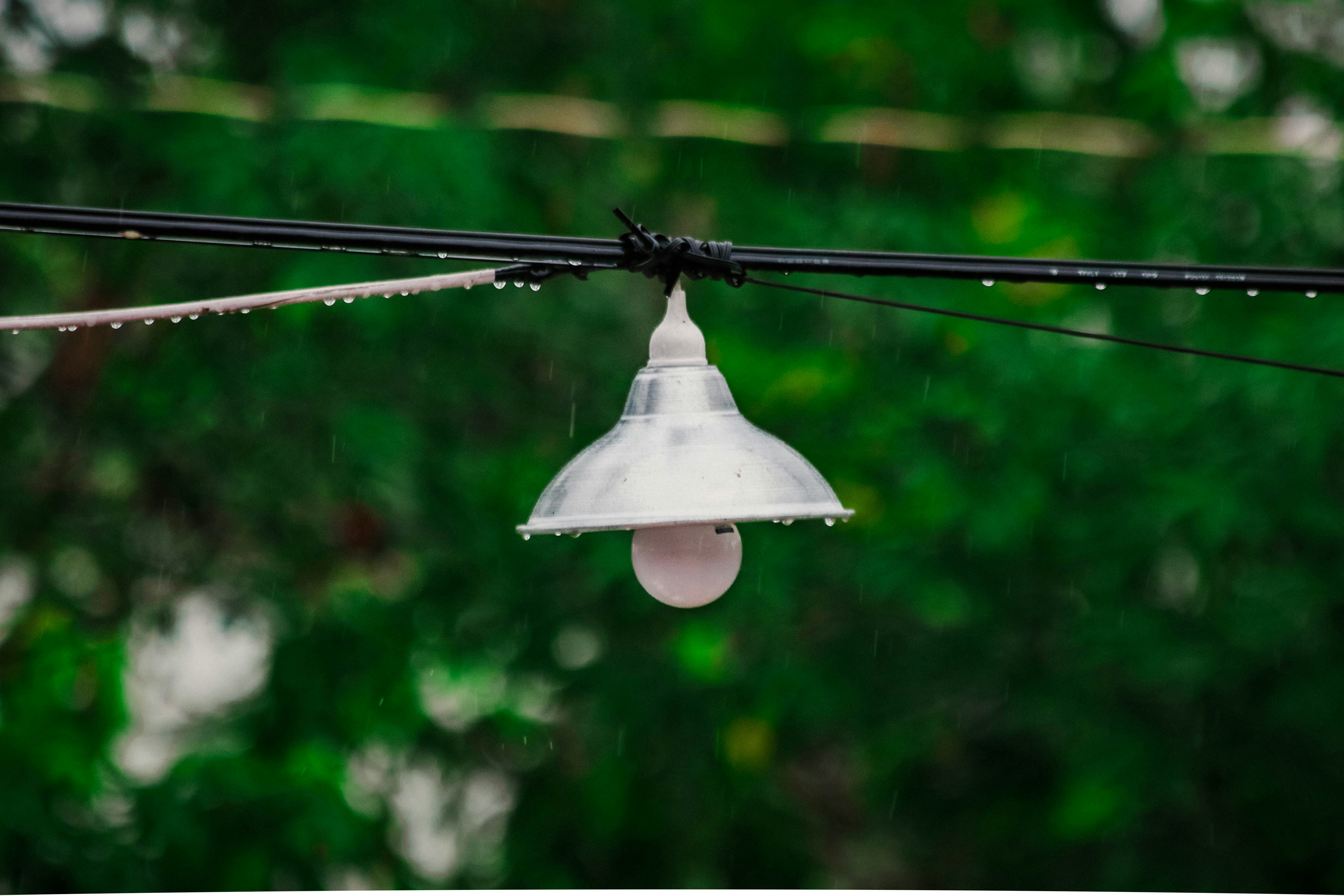 Hanging Lamp Under a Rain-Speckled Wire