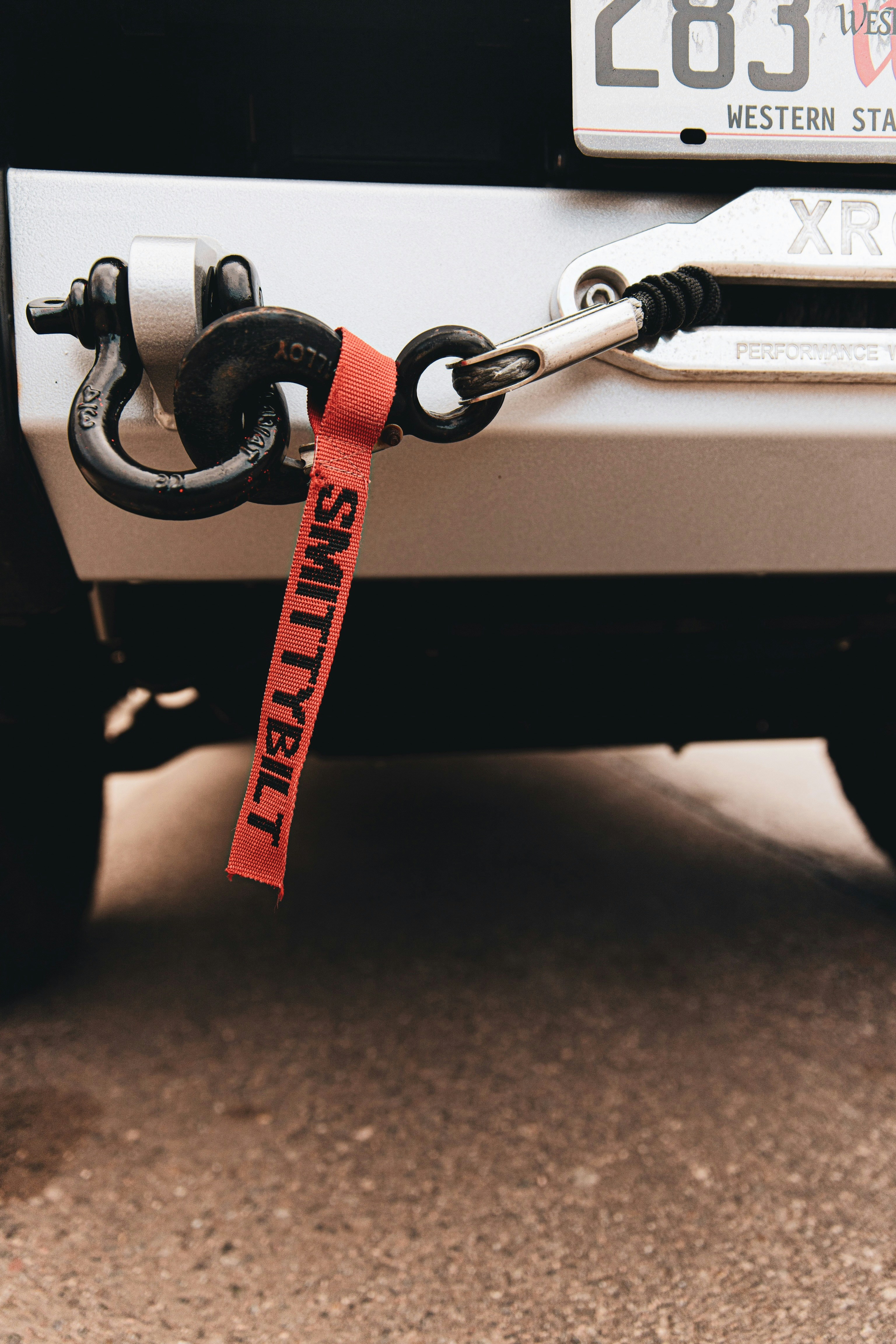 Bike Lock and Tether: A Close-Up of an Orange Strap on a Rear Car Hitch