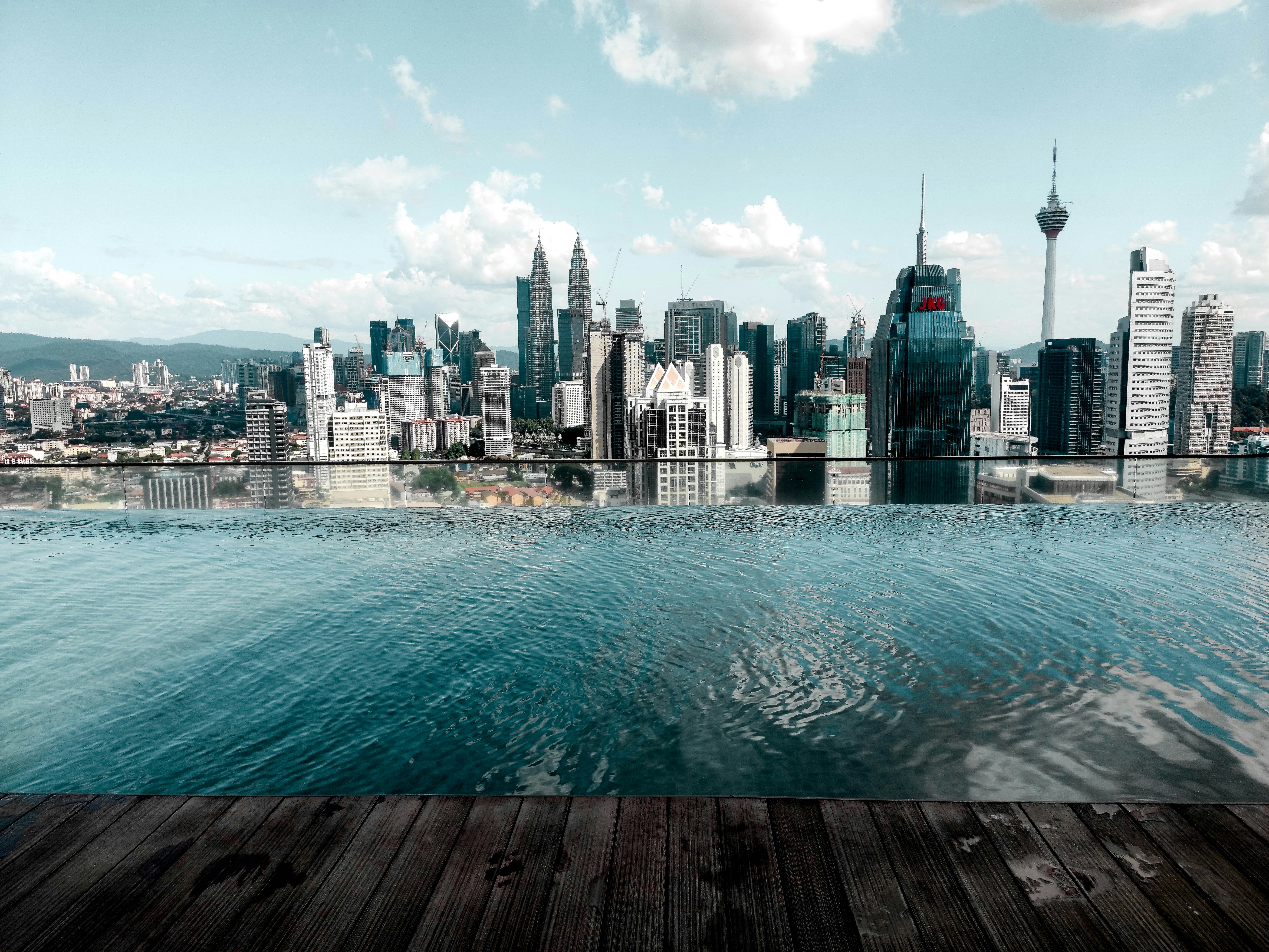 The famous sky pool in Kuala Lumpur with a stunning view of the skyline | body of water near city buildings during daytime