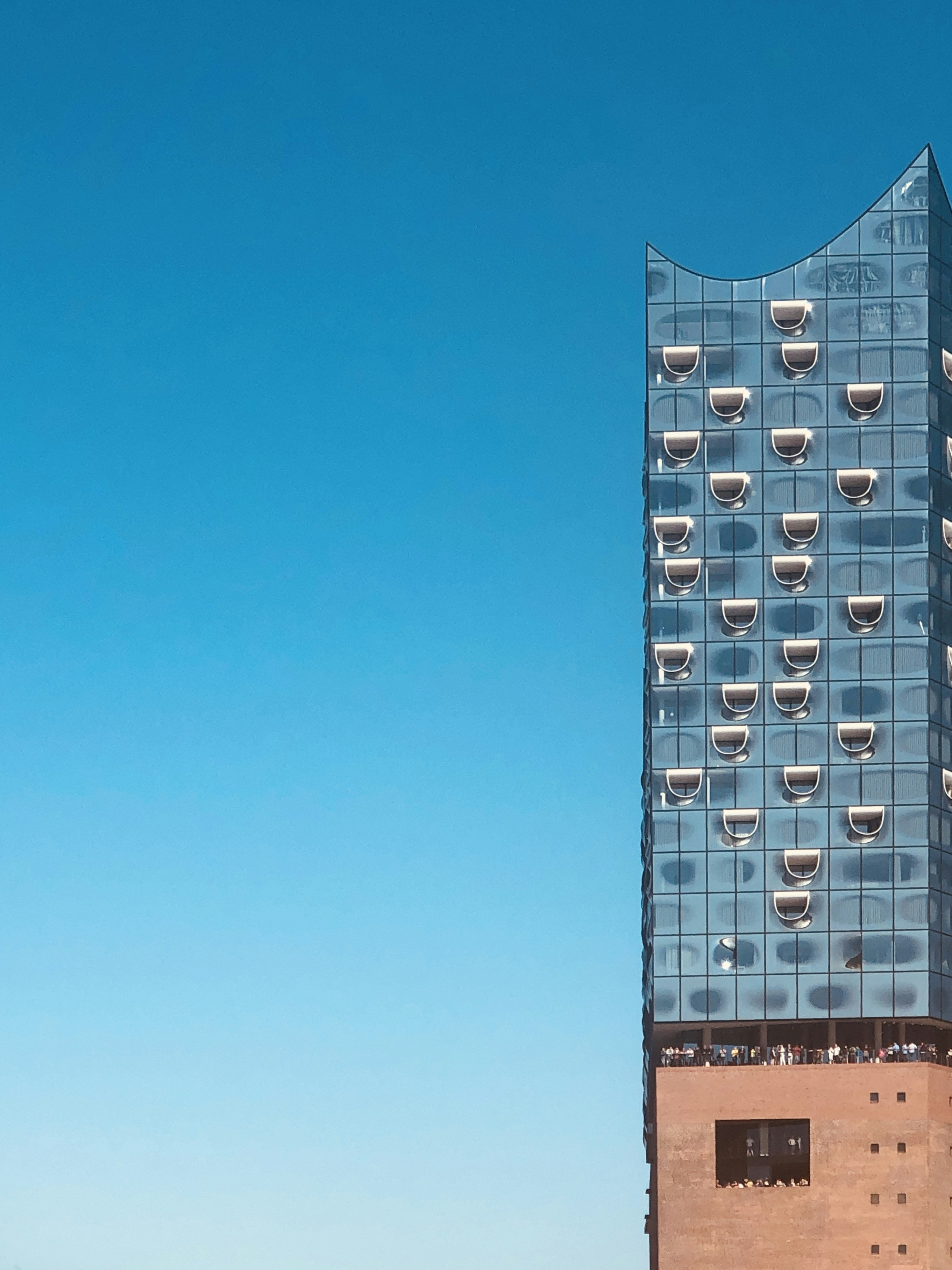 Cerulean Sky and the Curved Glass Tower