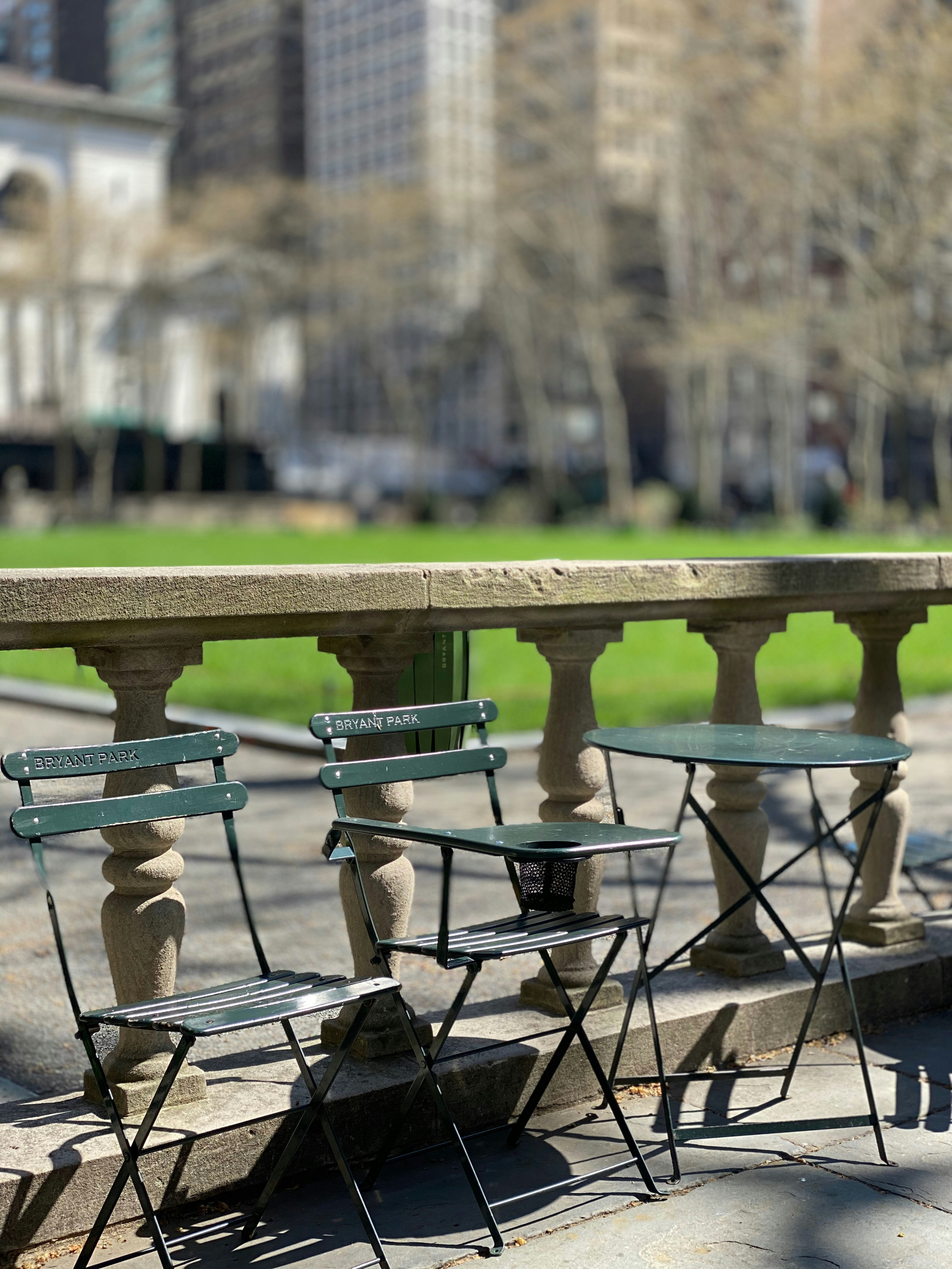 Black metal table and chairs on gray concrete floor photo – Free ...