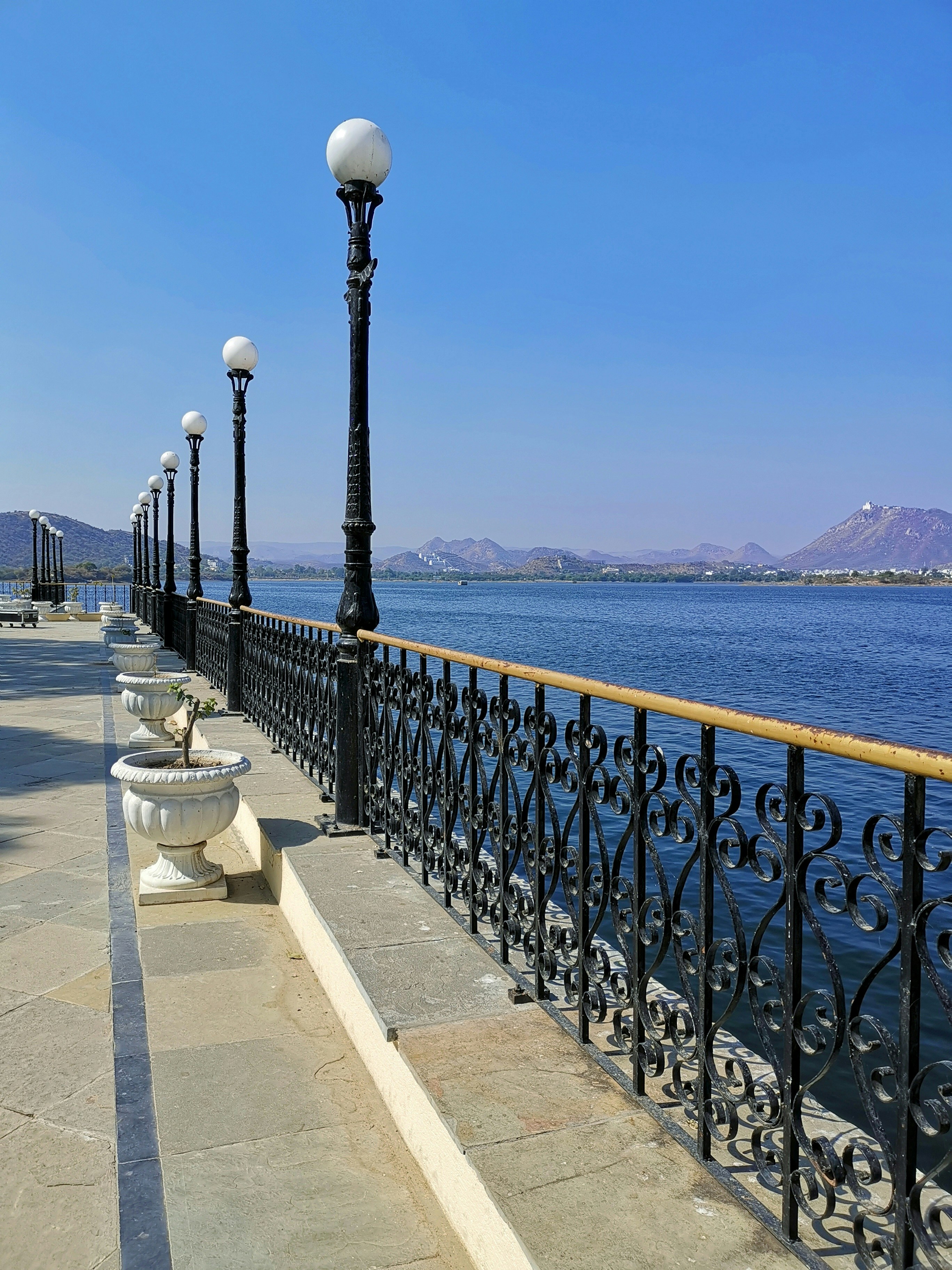 Iron Lanterns Framing a Sunlit Seaside Promenade