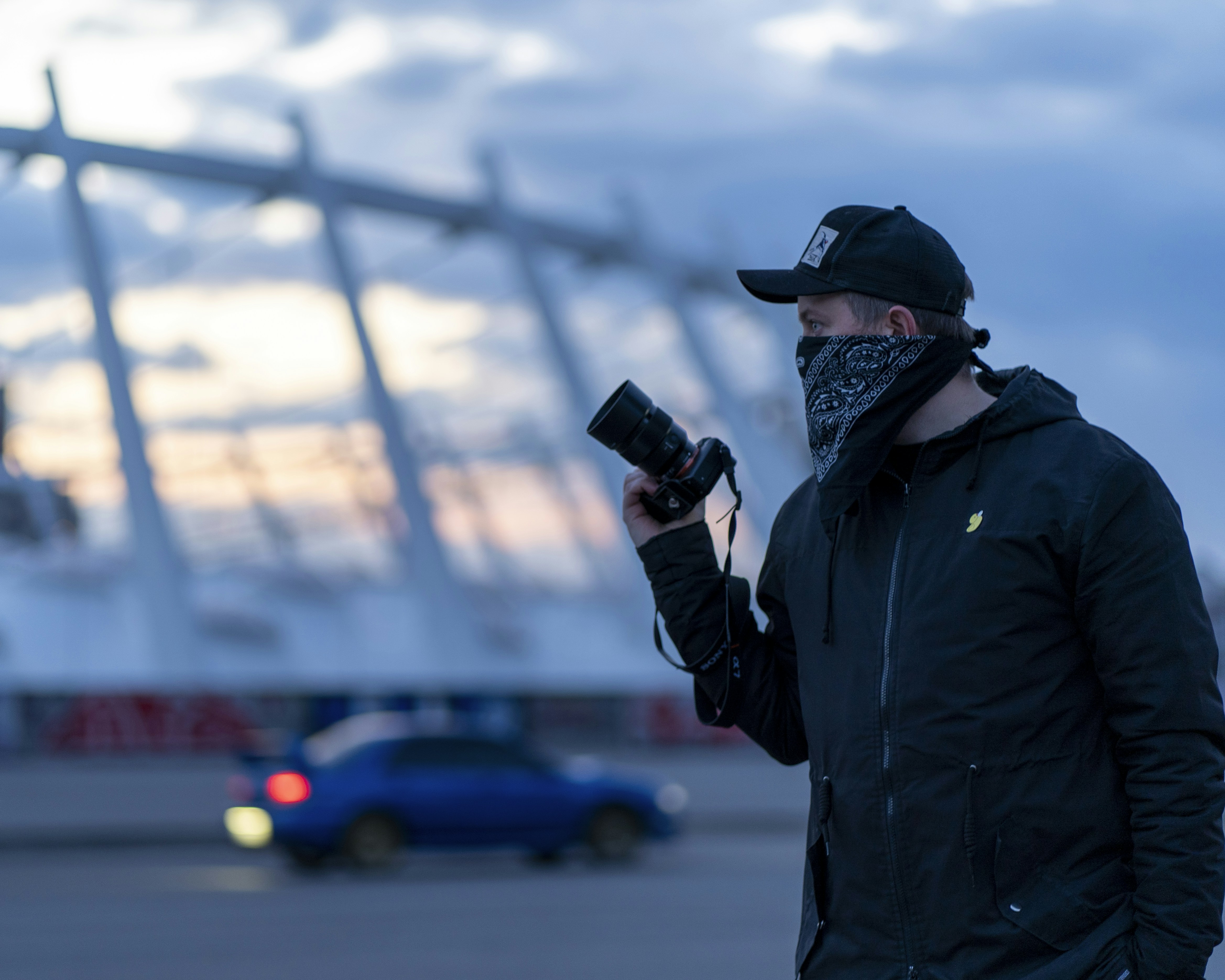 Twilight Frames: A Masked Photographer on a Rooftop