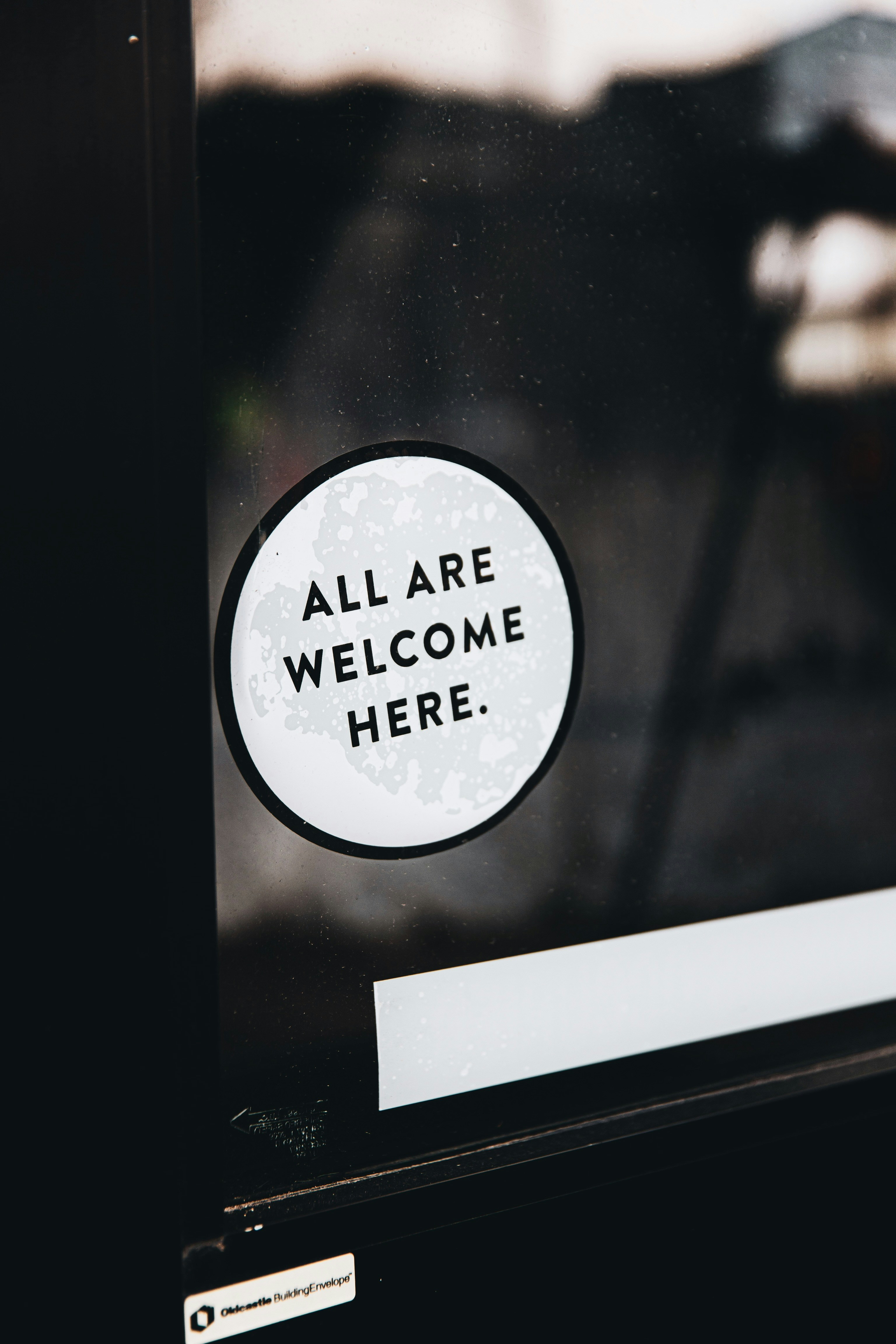 A sticker that says all are welcome here photo – Free Grey Image on ...