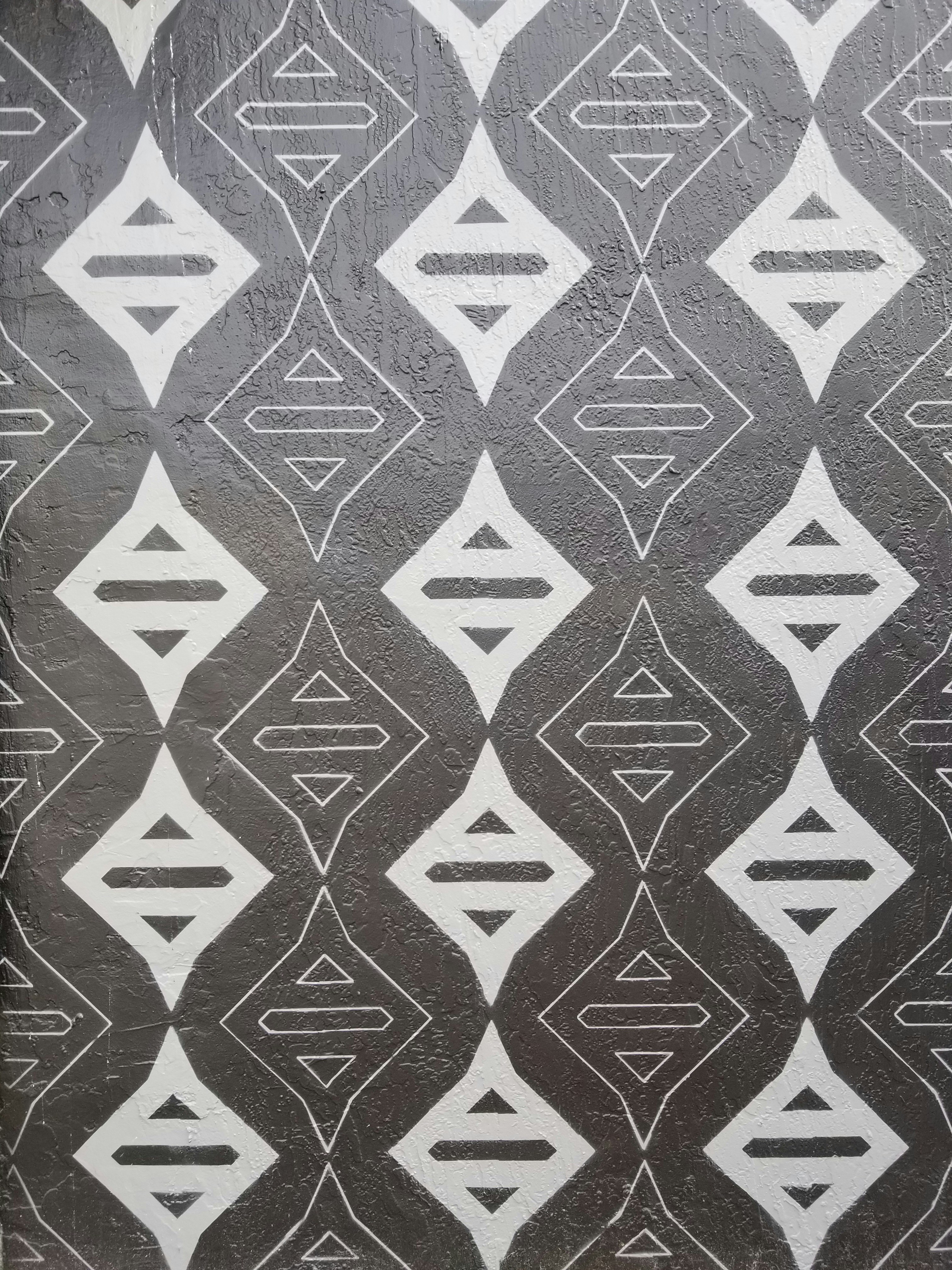 Intricate black and white geometric pattern featuring diamonds and lines, creating a rhythmic visual flow.