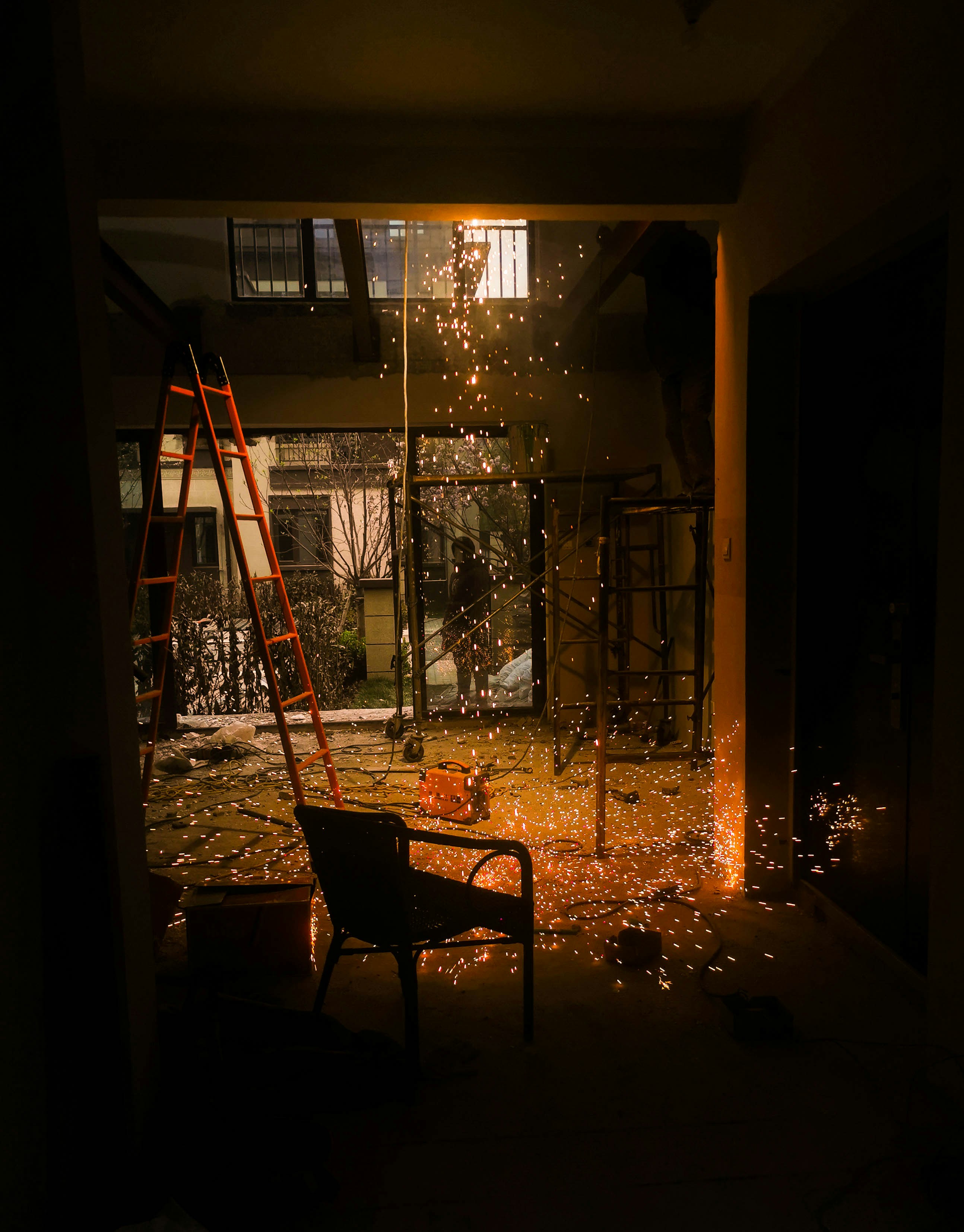 Sparks in a Half-Built Hall: A Night-Shift Scene