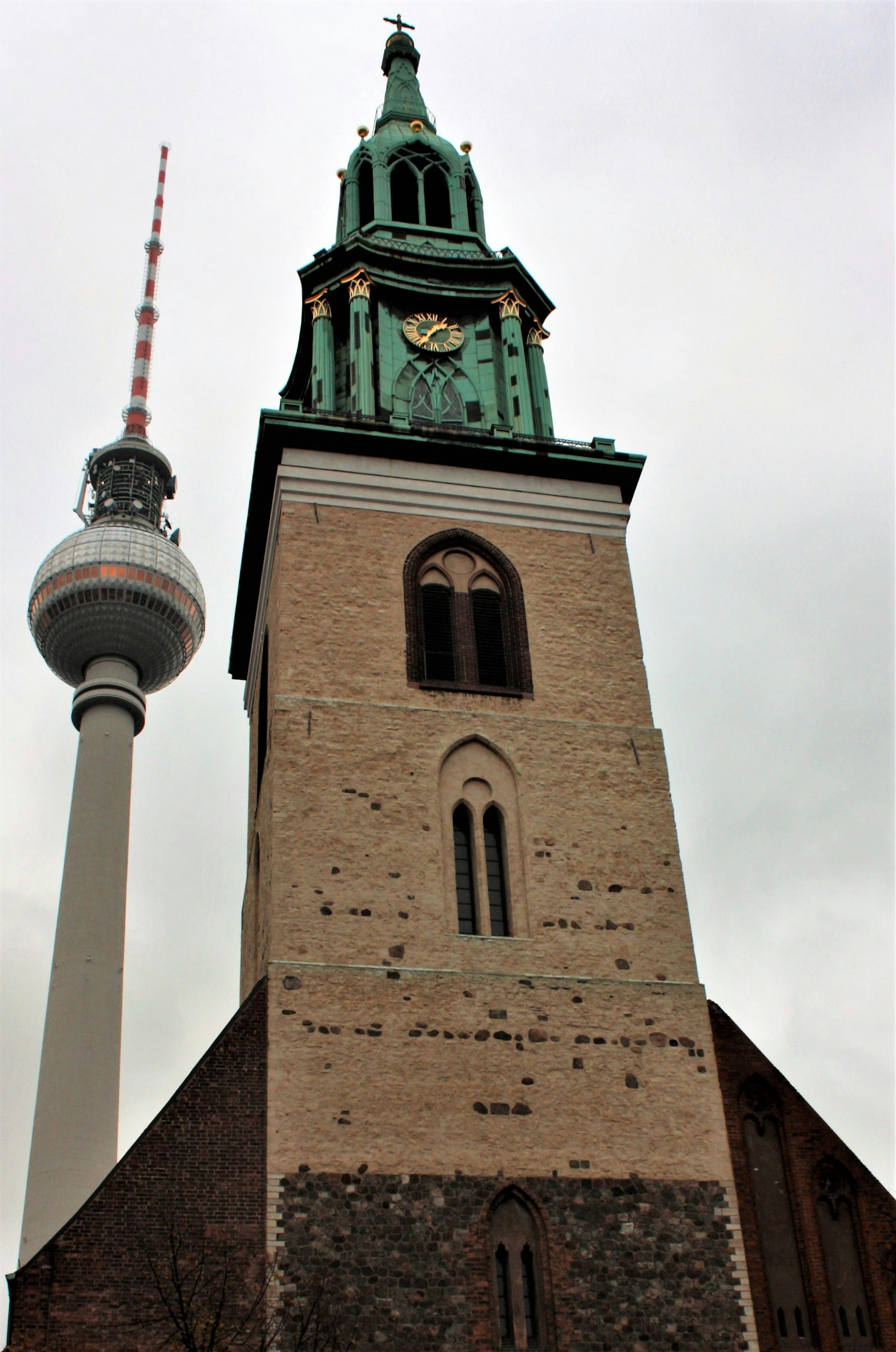 Green-Spired Crown Over Brickwork: Berlin’s Dual-Tower Silhouette