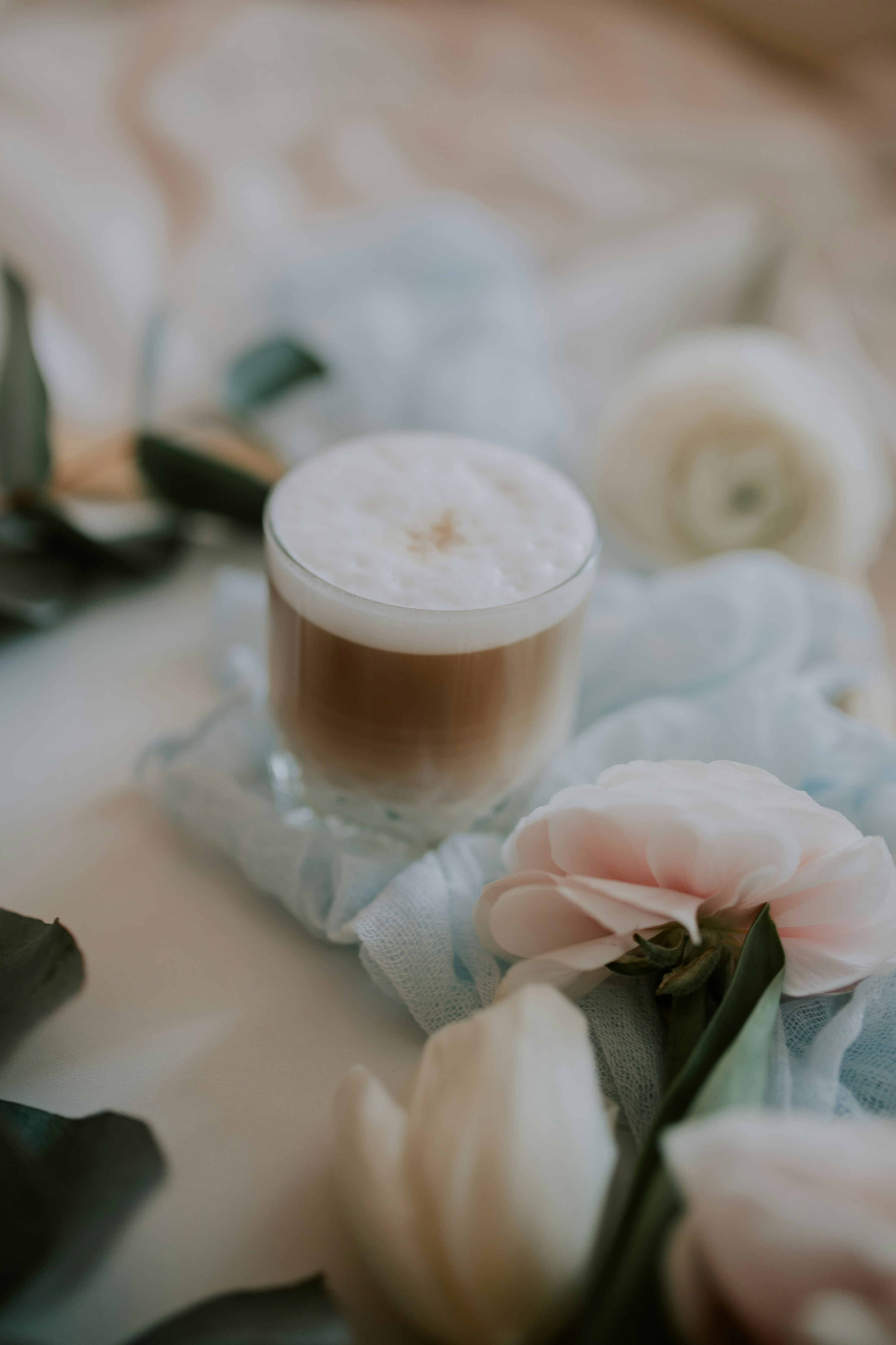 Layered Latte in a Glass: Quiet Morning Among Blue Gauze and Blush Roses