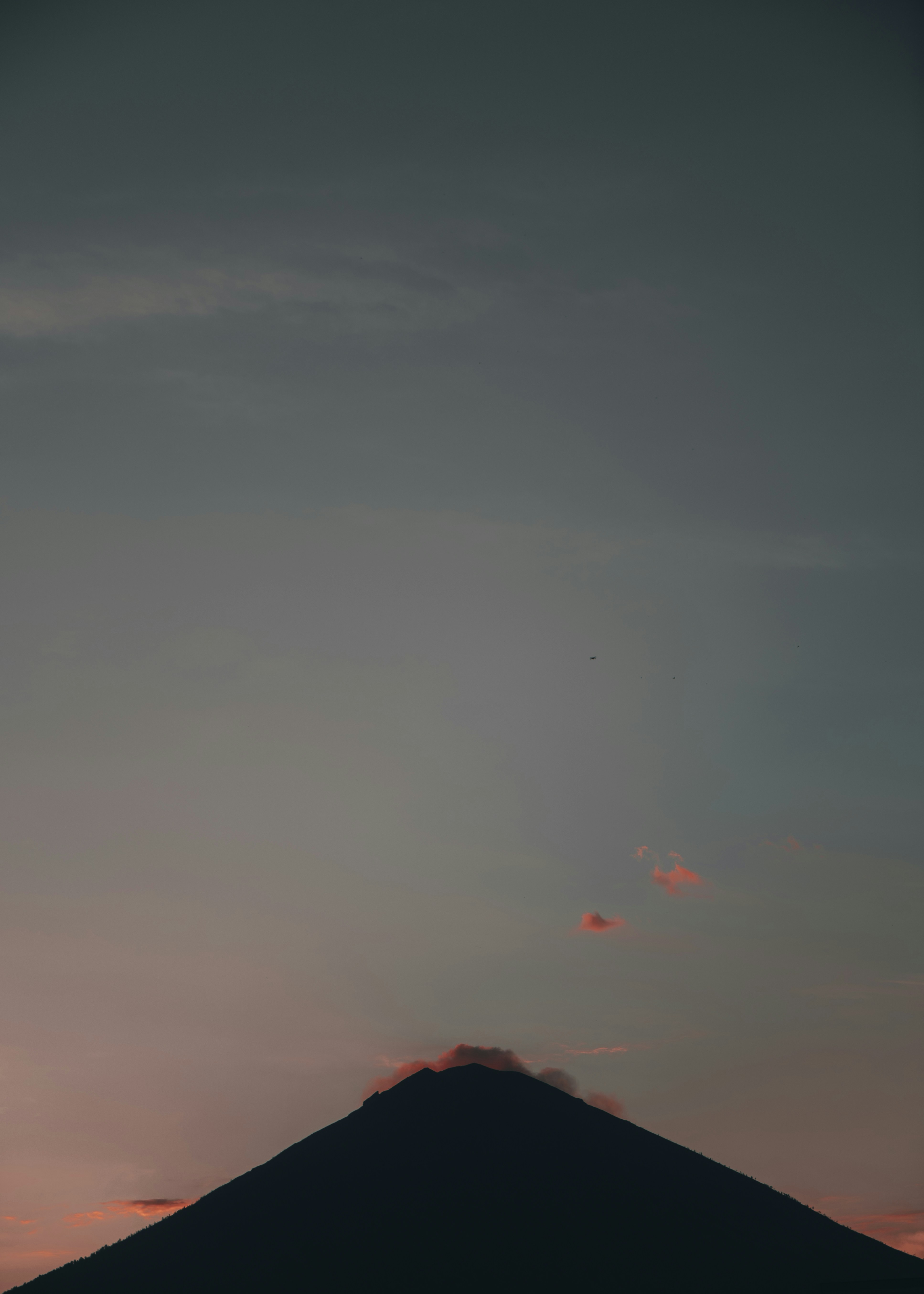 Dusk Summit: A Solemn Silhouette Beneath a Quiet Gradient Sky