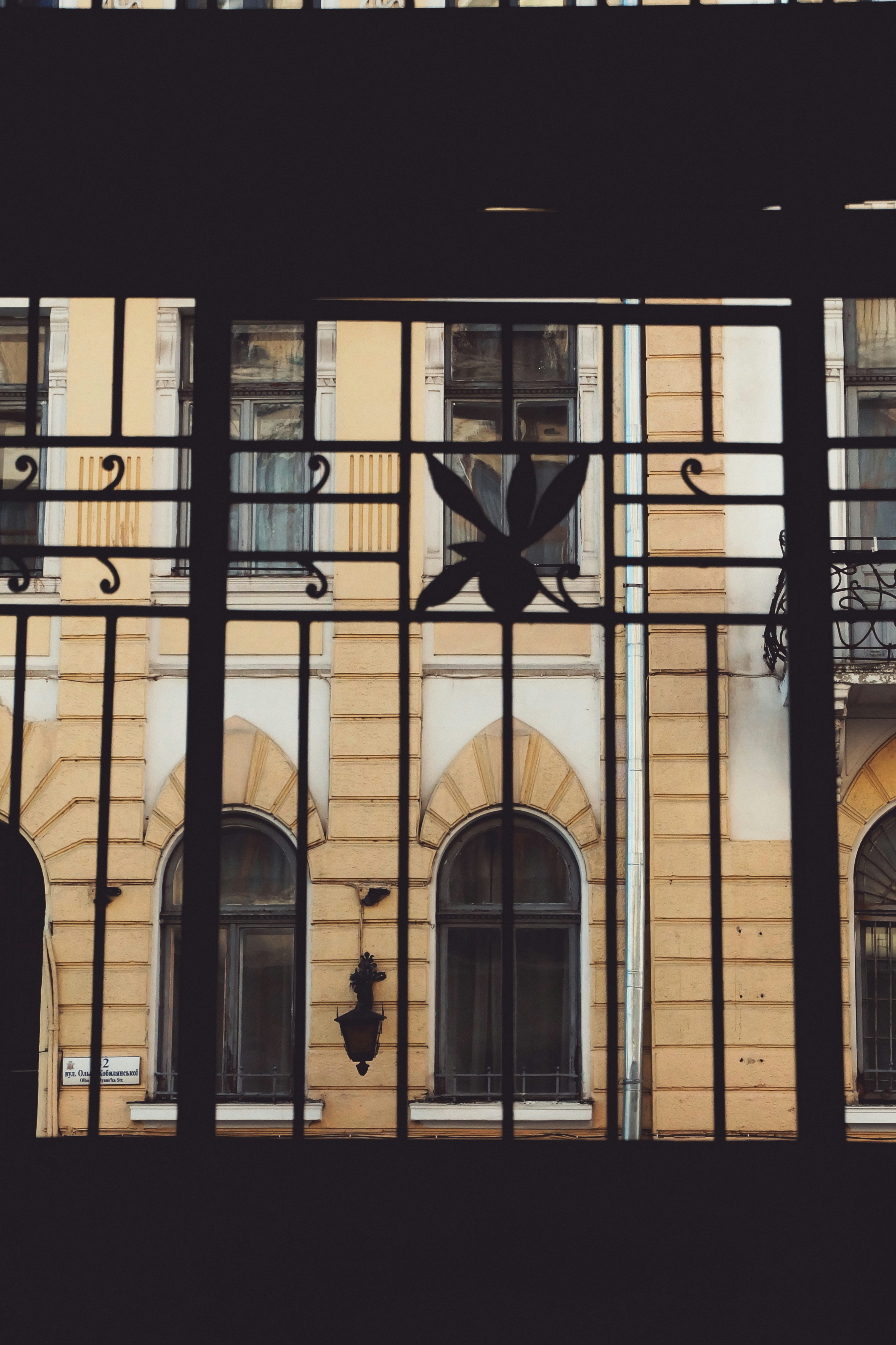 Stellar Grille: Light Through a Yellow City Facade