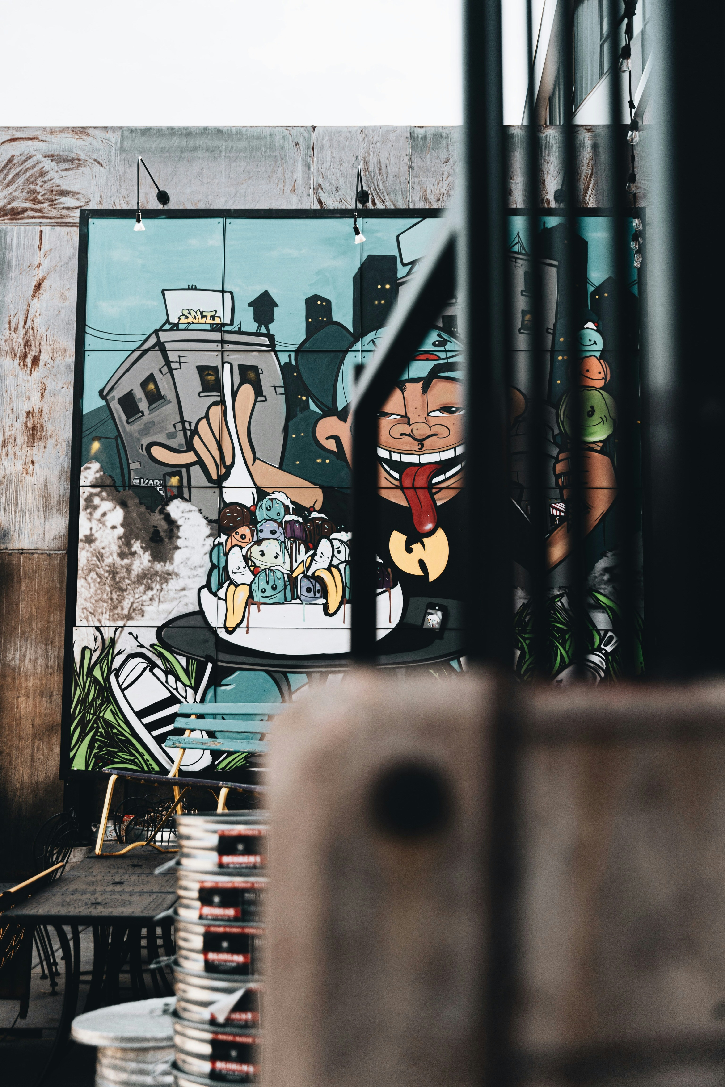 Ice-Cream Idol Behind Industrial Grids: A Graffiti Portrait