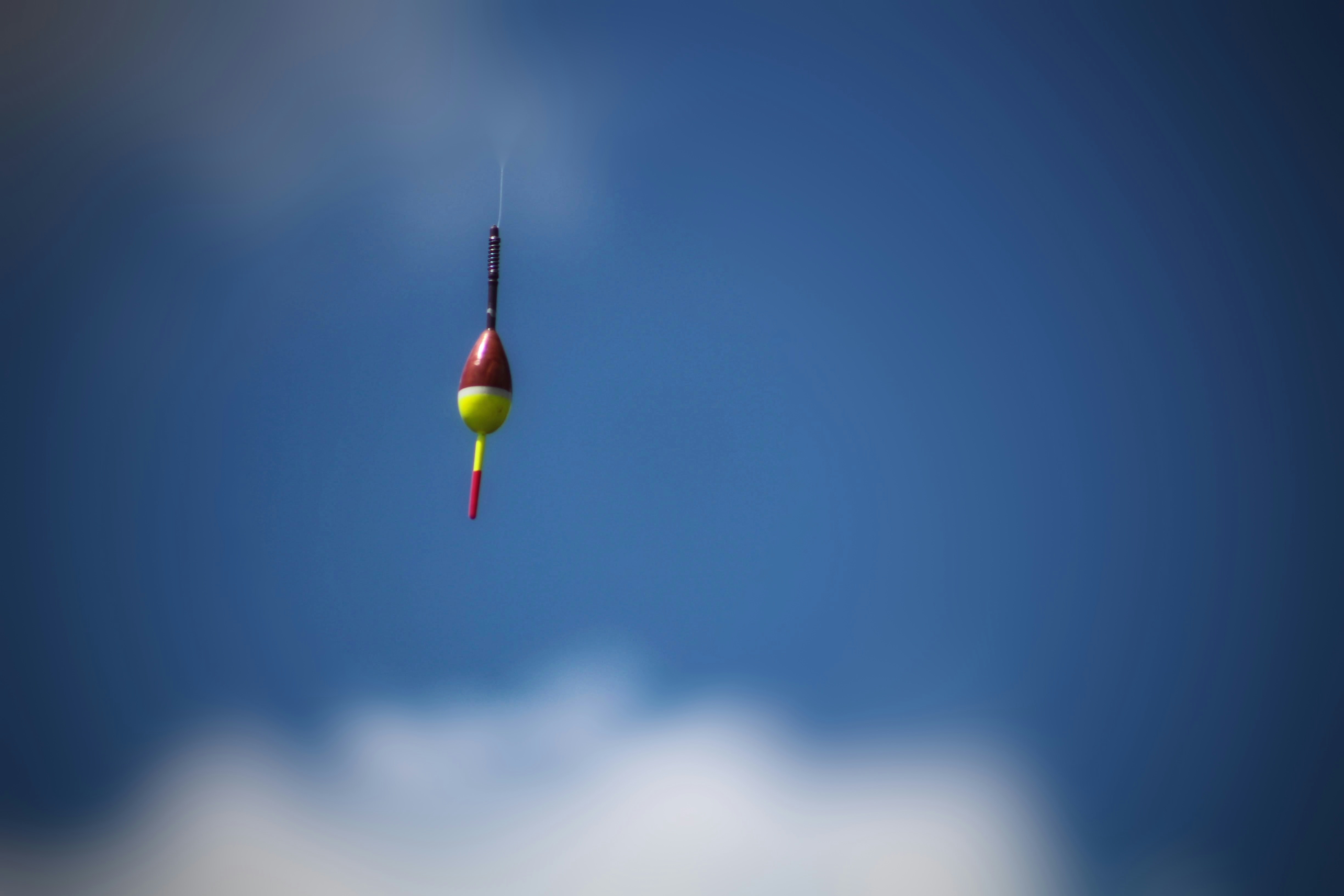 Isolated Buoy Drifting Against a Clear Sky