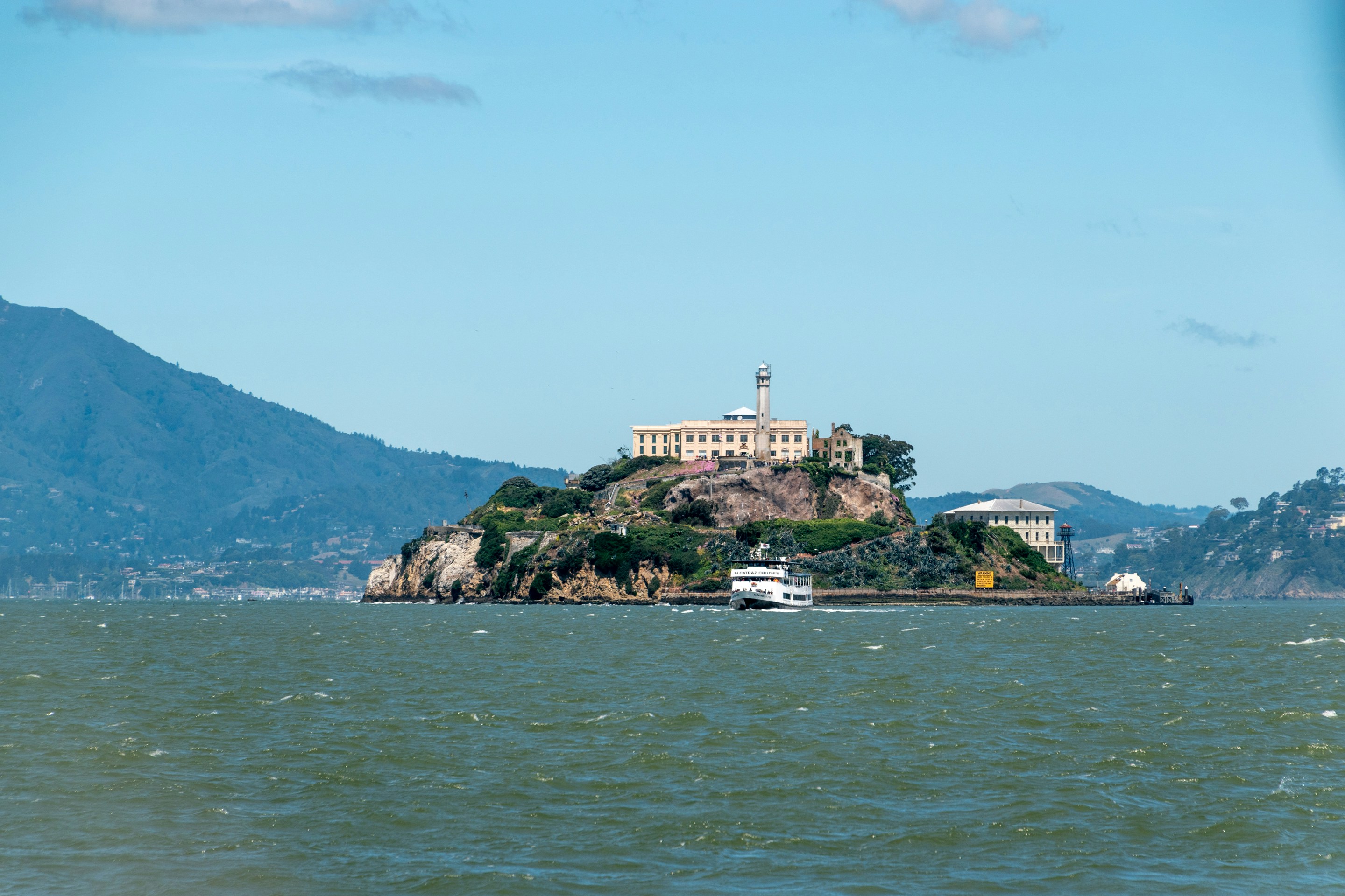White and brown concrete building on island surrounded by water under ...