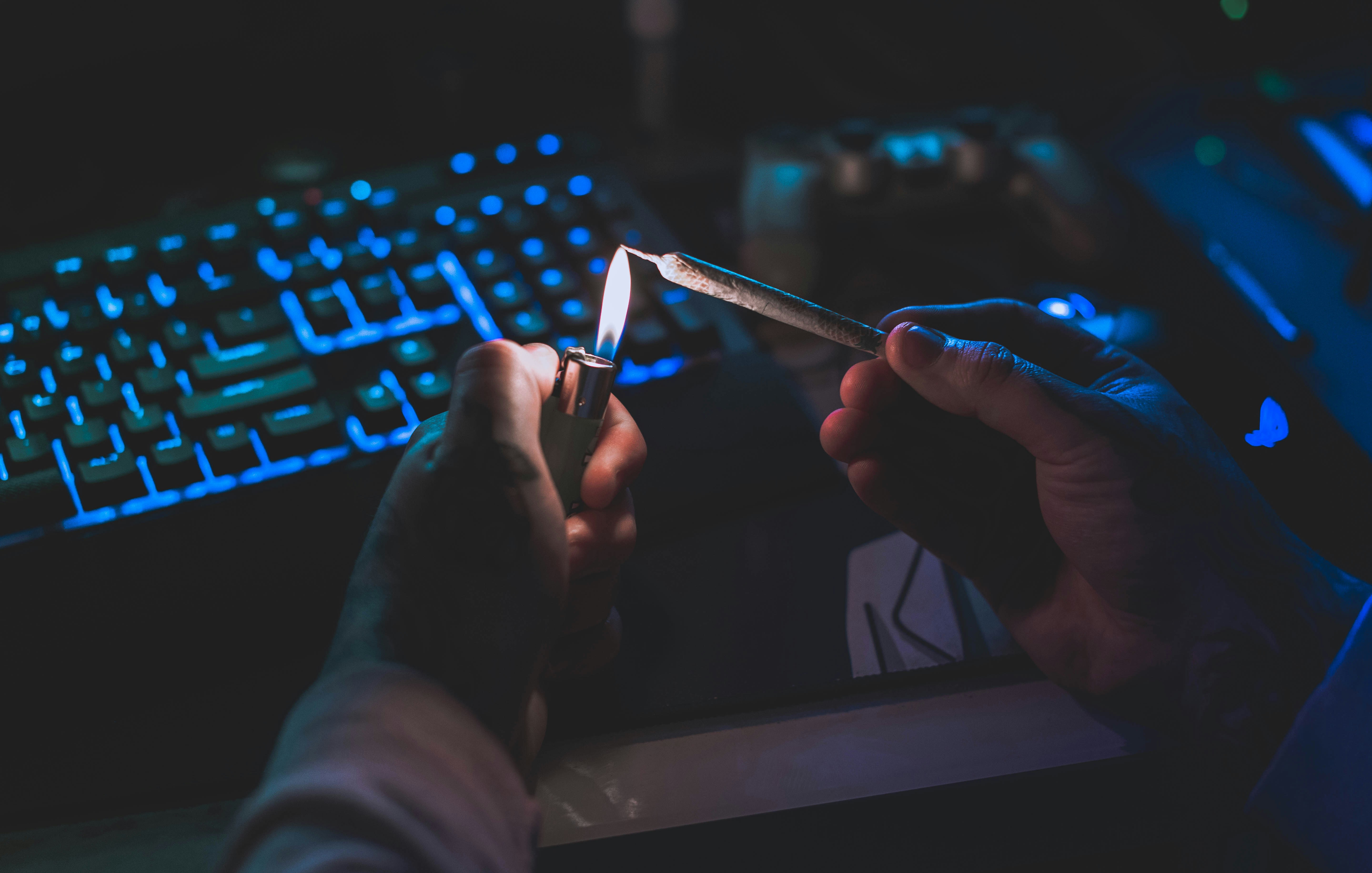 Midnight Craft: Fingers and Blade under Neon Keyboard Glow