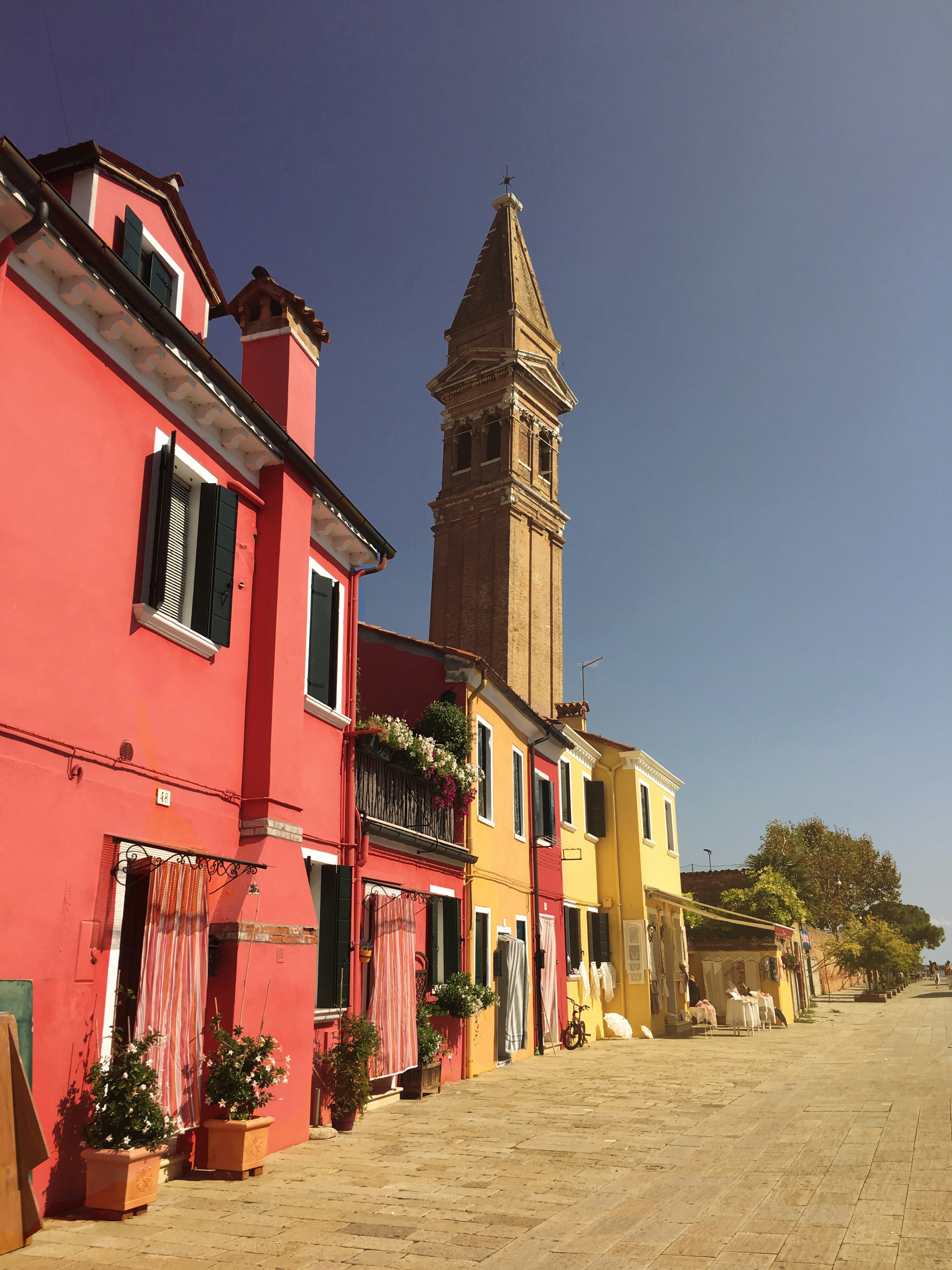 Sunlit Calle dei Colori: A Venetian-esque Row with a Tower