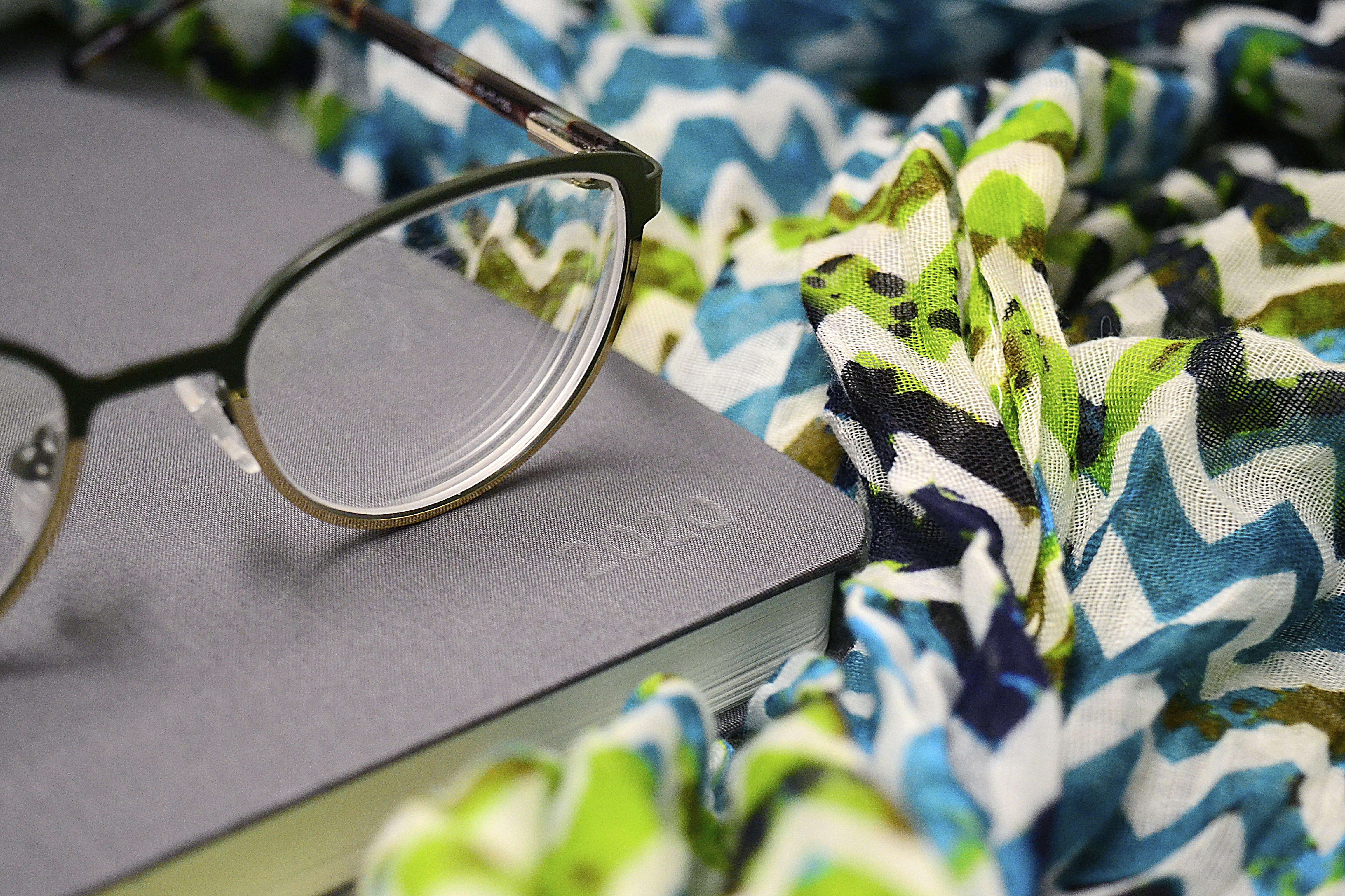 Close-up of Reading Glasses: Colorful Fabric Framing a Quiet Moment