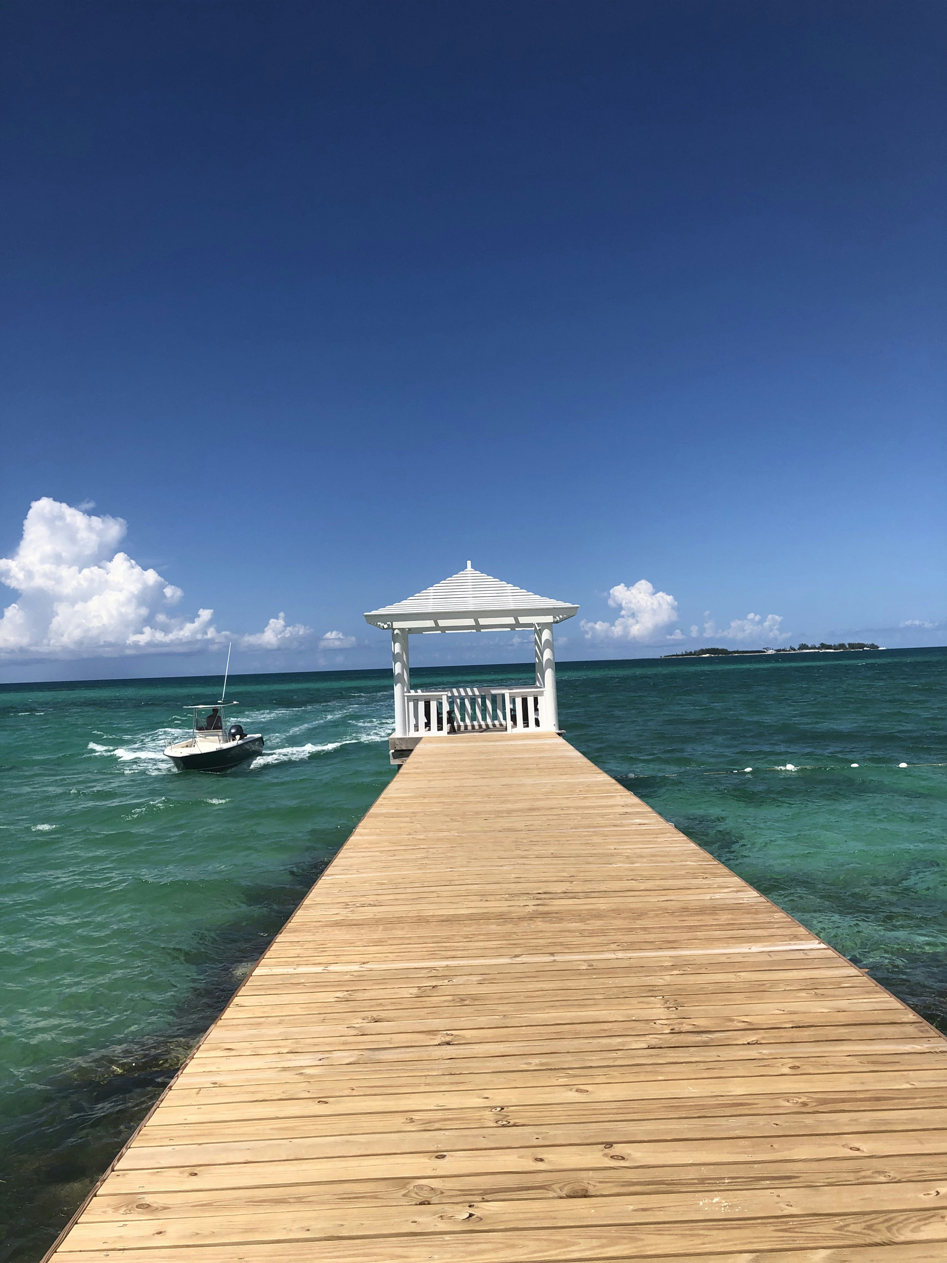 White wooden dock on sea under blue sky during daytime photo – Free ...