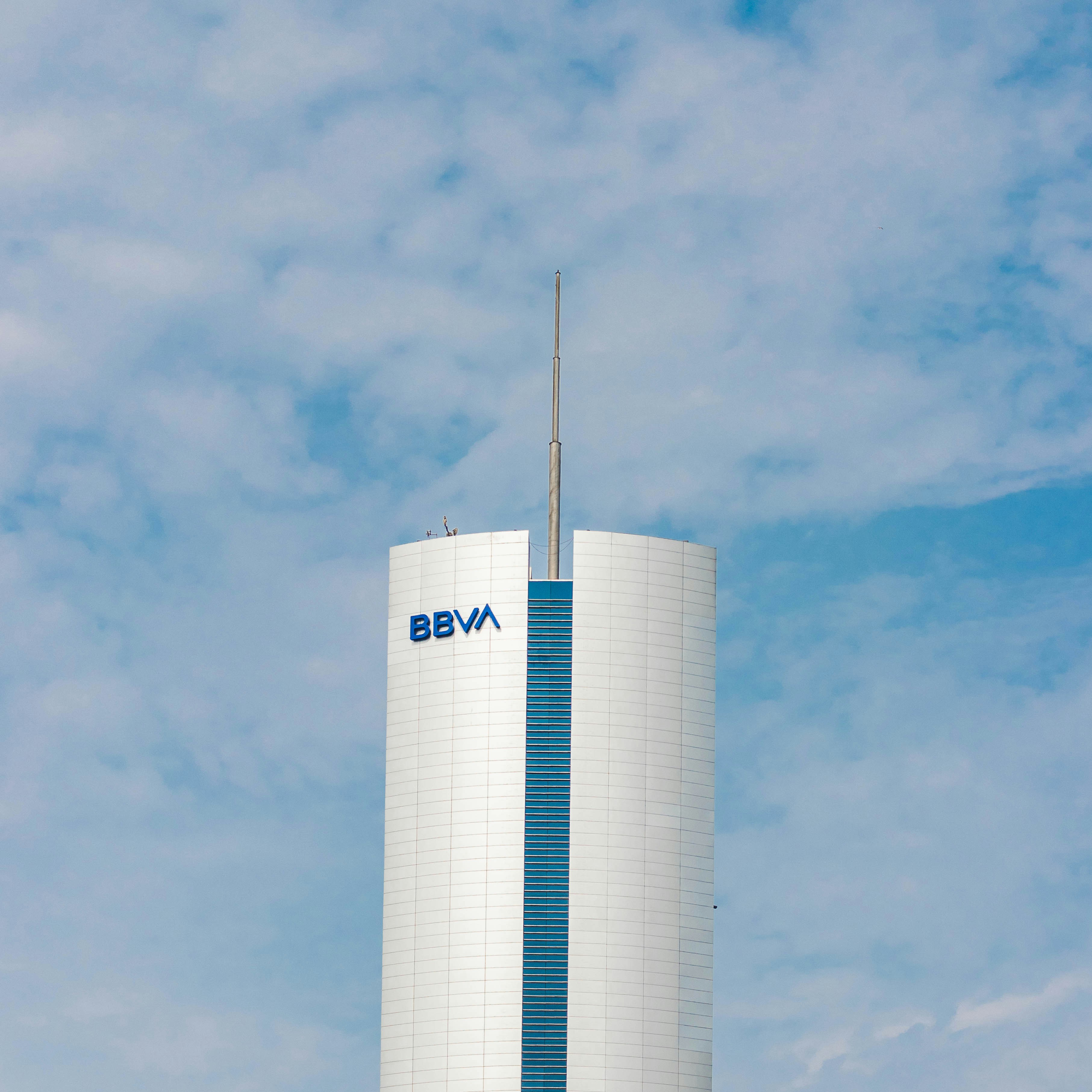 Tall skyscraper featuring the BBVA logo, set against a clear sky, showcasing modern architectural design.