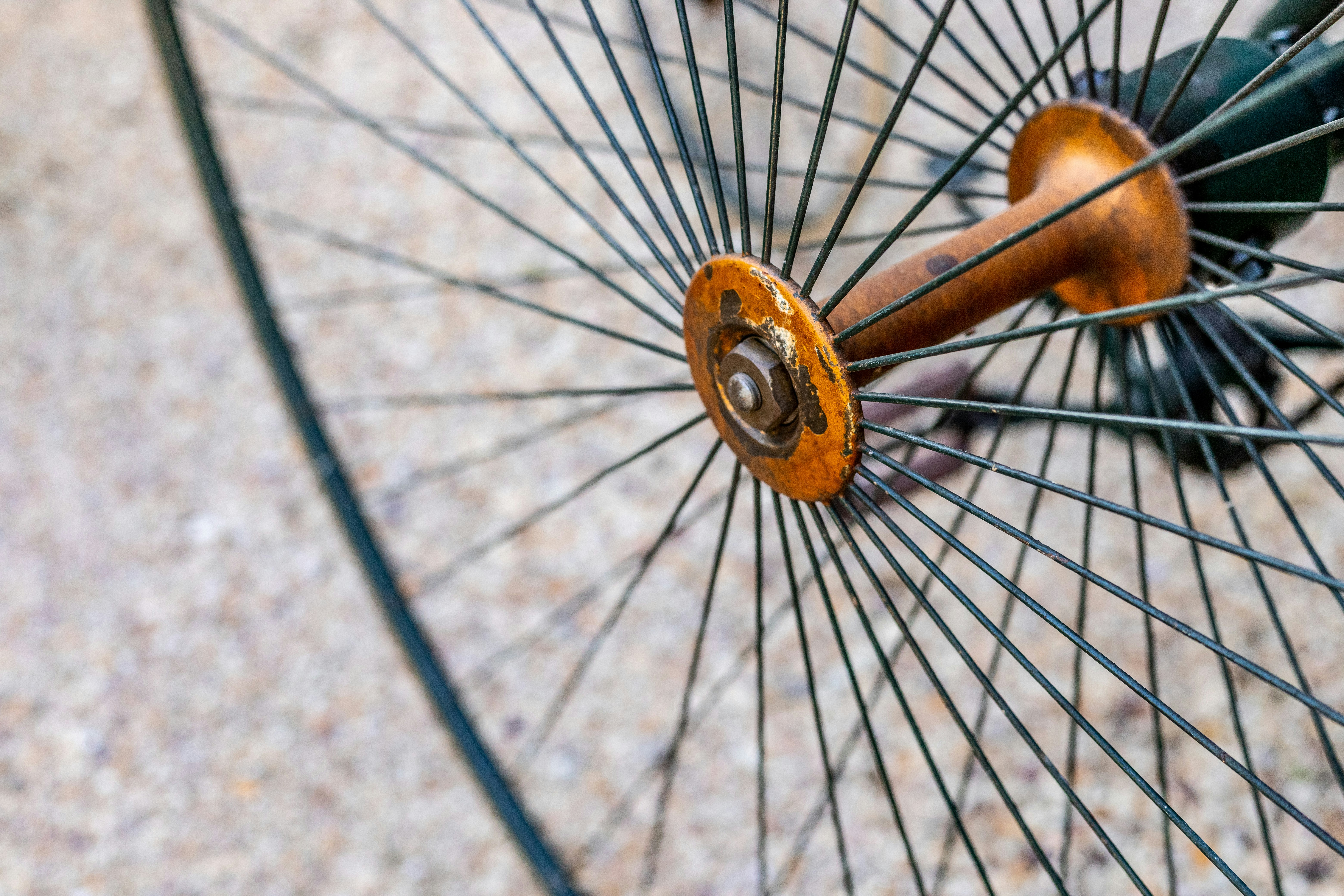 brown metal wheel on grey concrete floor