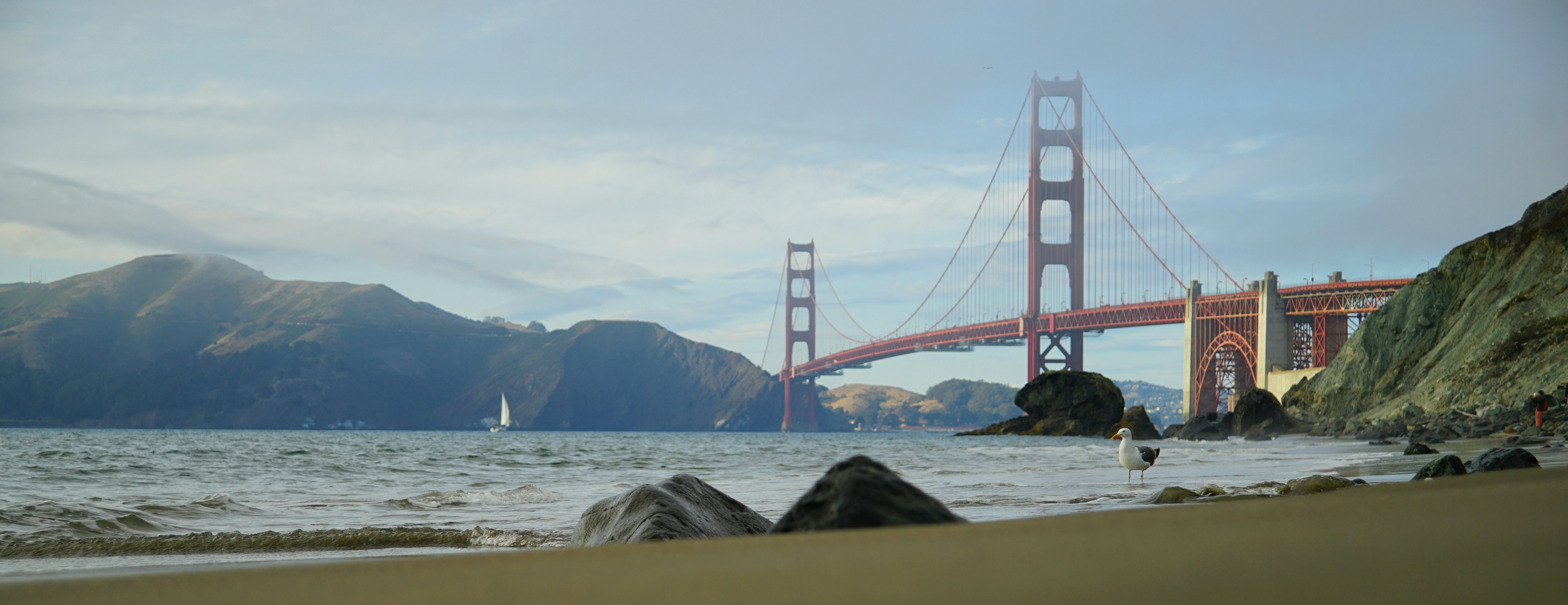 Golden Span at Dusk: ASeaside View of the Bridge