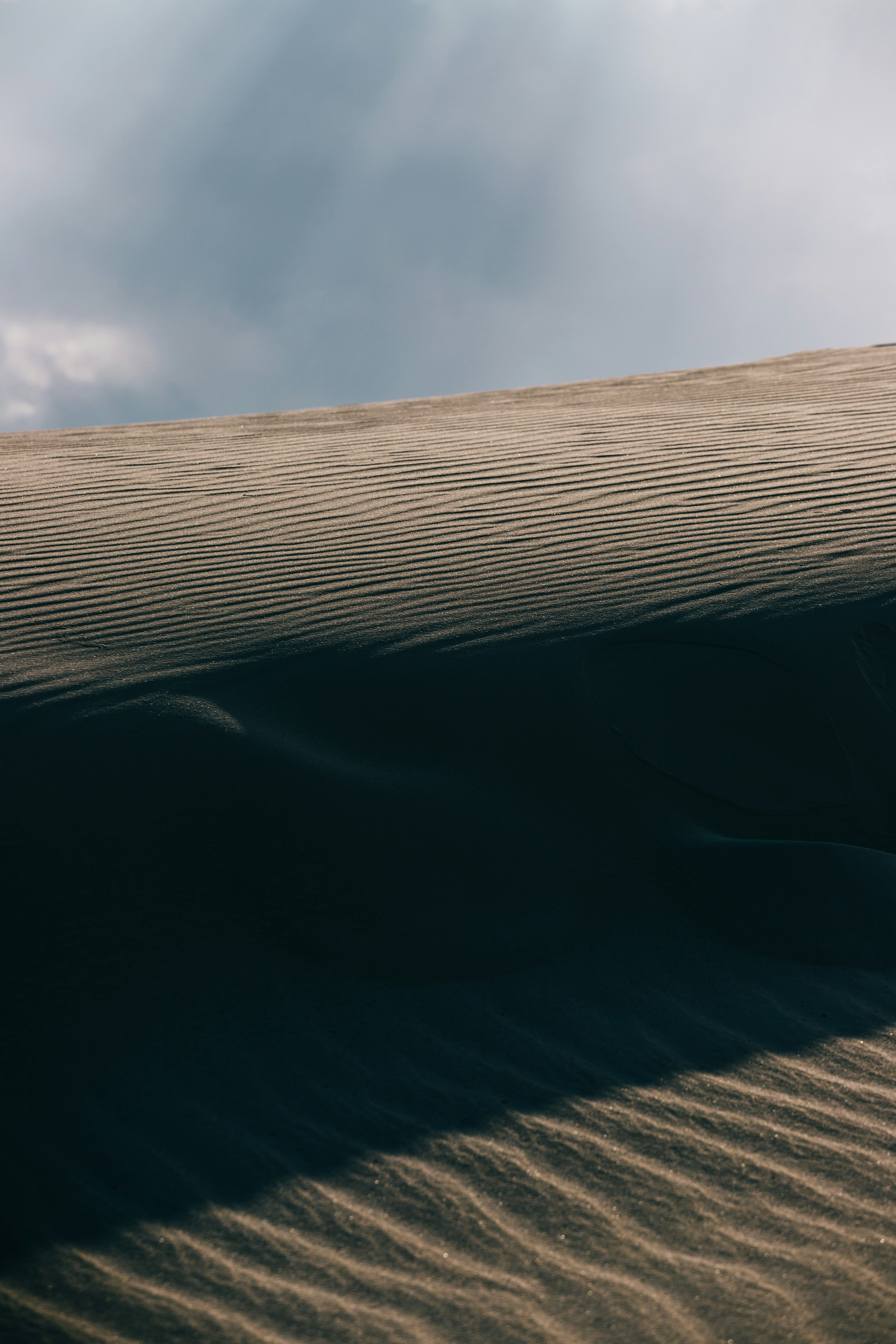 brown sand under blue sky during daytime