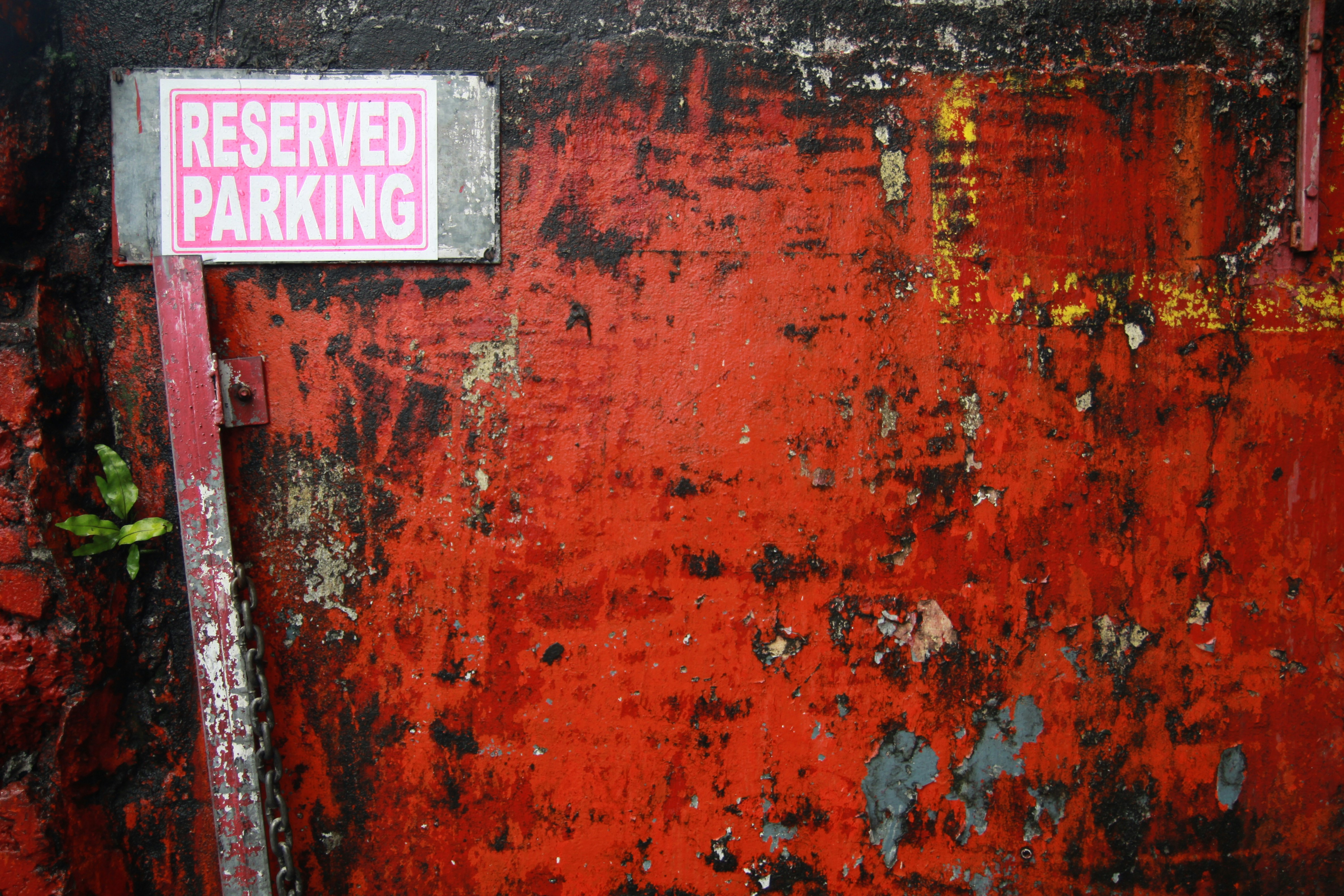 Reserved parking. Bright red wall