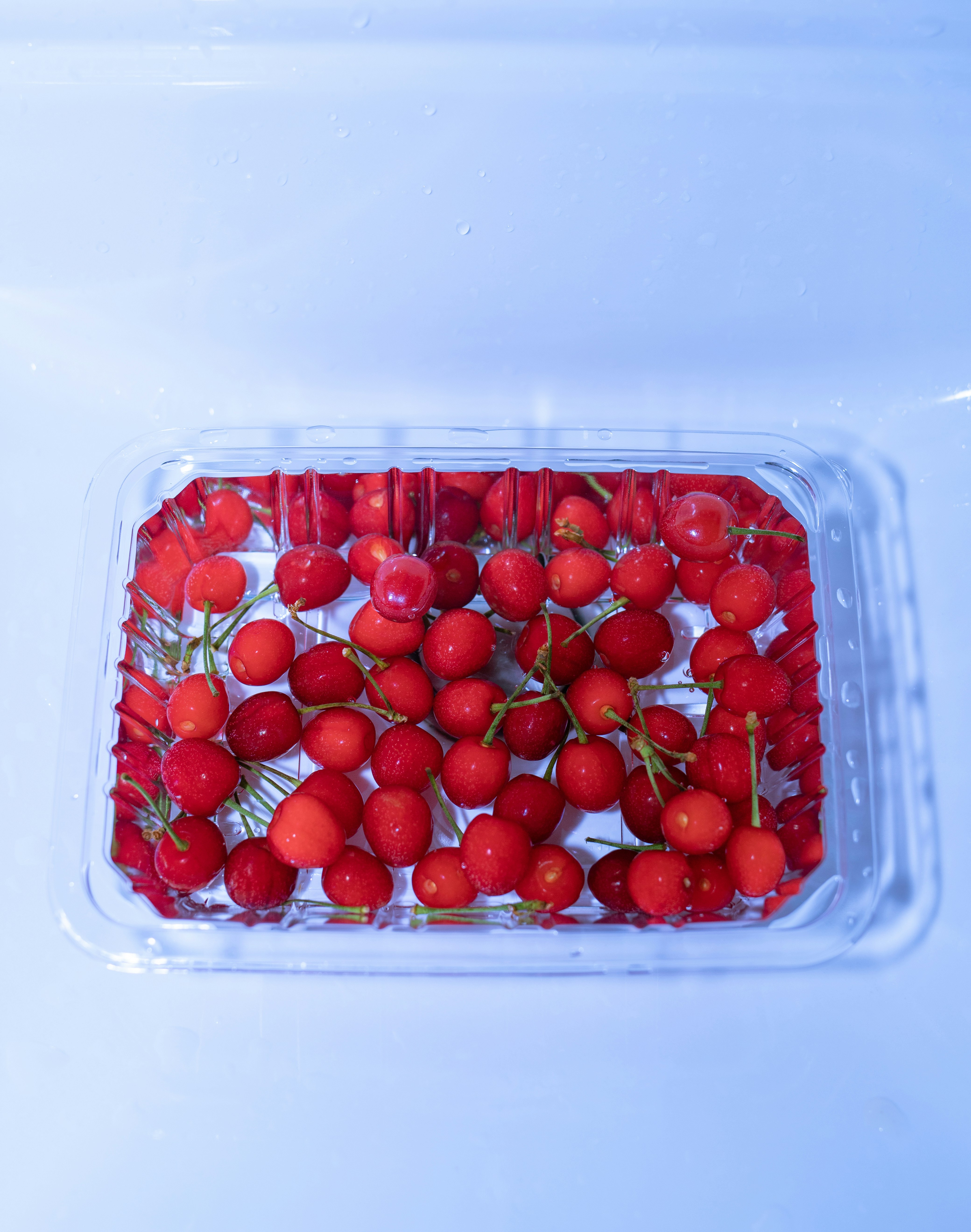red round fruits in white plastic container
