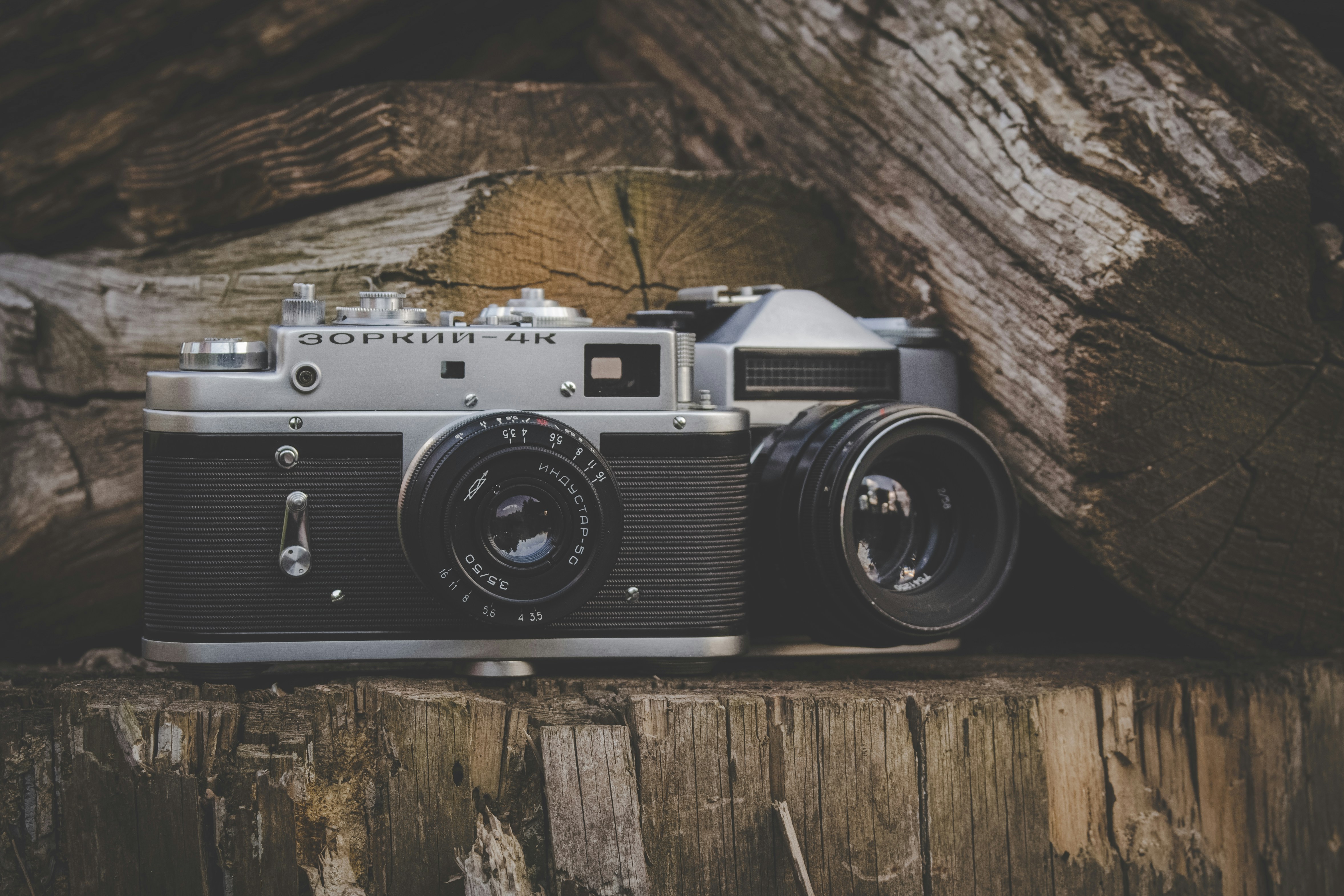 Analog Timekeeper: A Silver SLR Resting on Weathered Wood